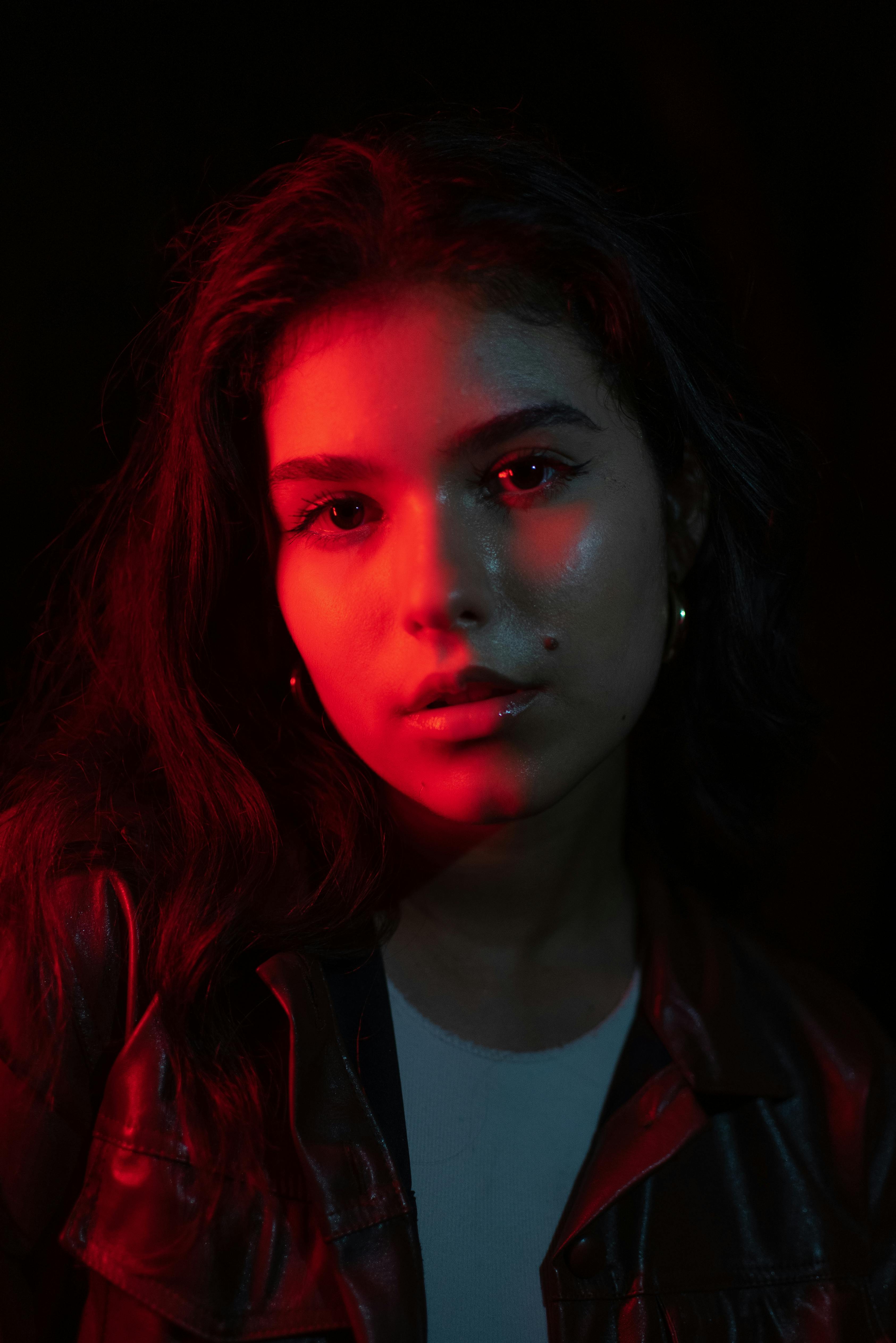 Portrait of Brunette Woman in Red Light · Free Stock Photo