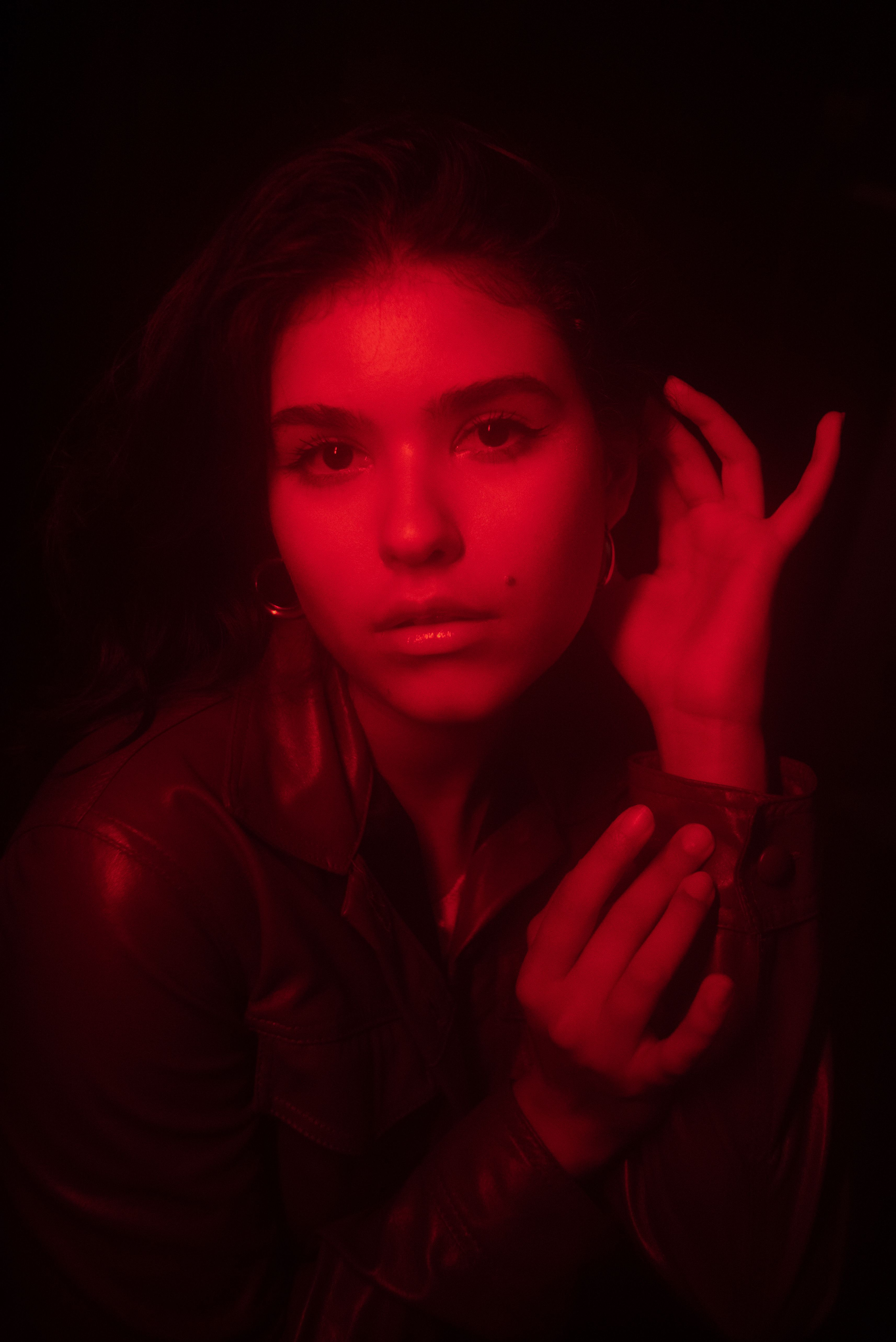 Studio Portrait of a Young Woman in Red Lighting · Free Stock Photo