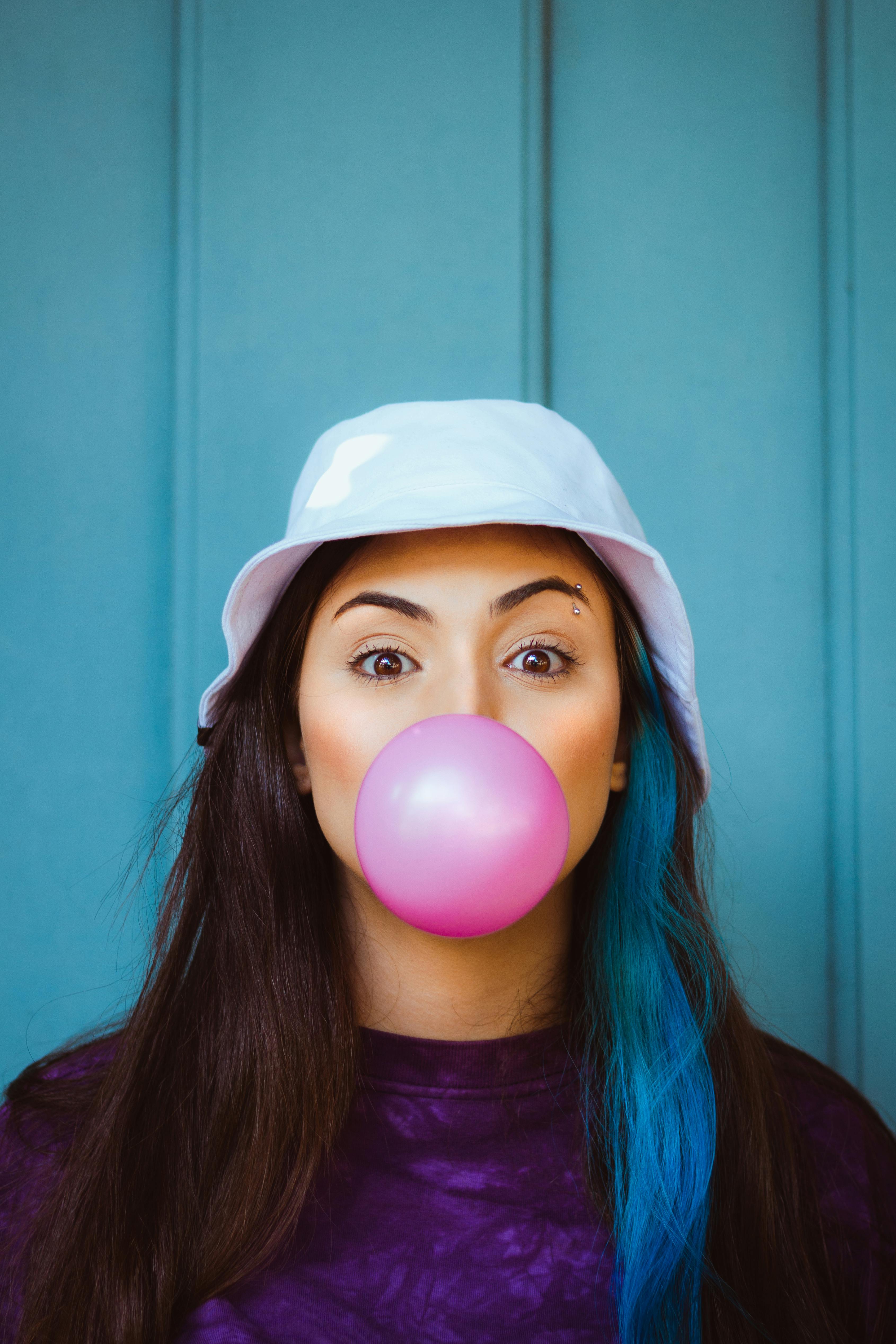 Woman Blowing a Pink Bubble Gum · Free Stock Photo