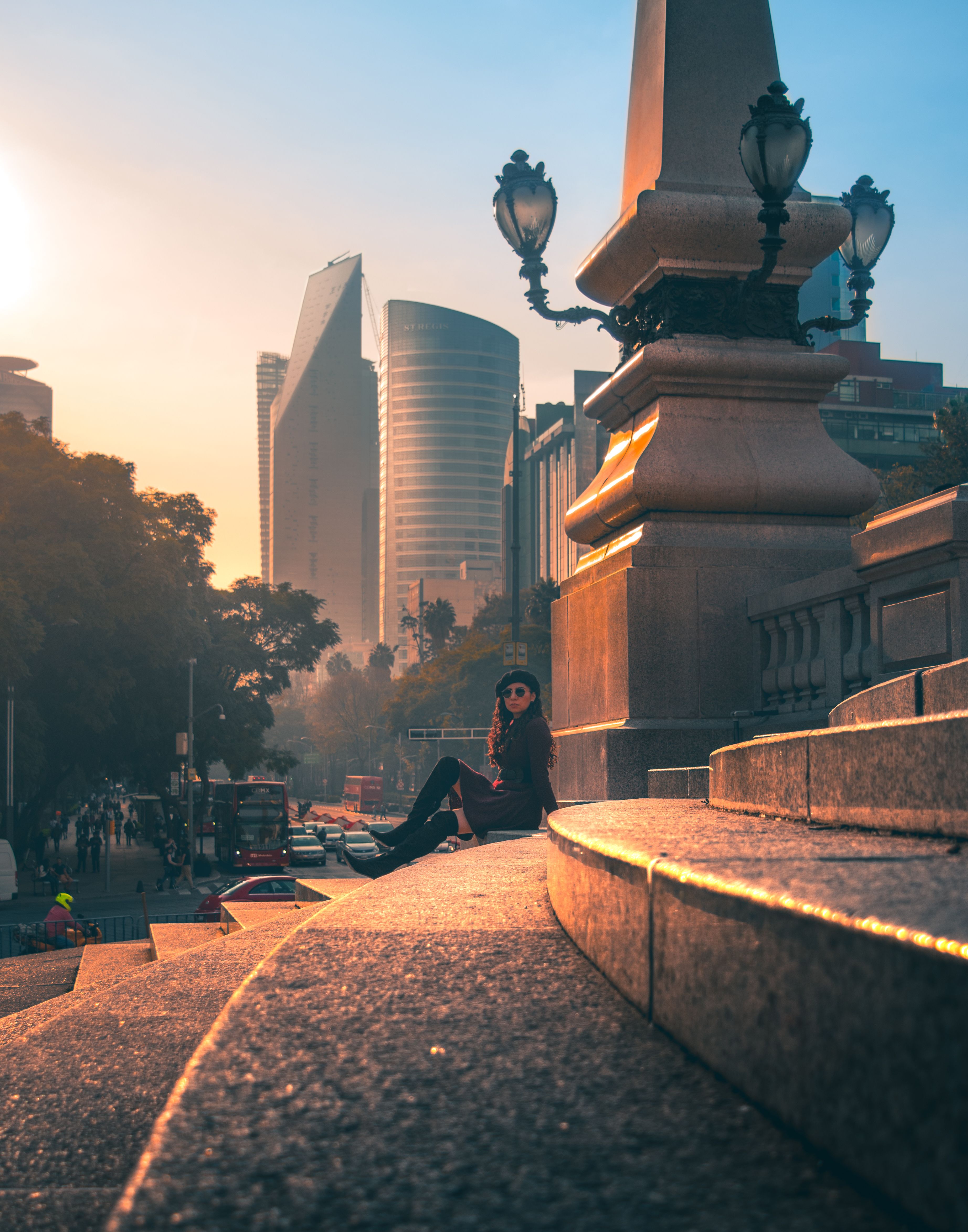 Woman Sitting on Steps in Front of Modern Building · Free Stock Photo