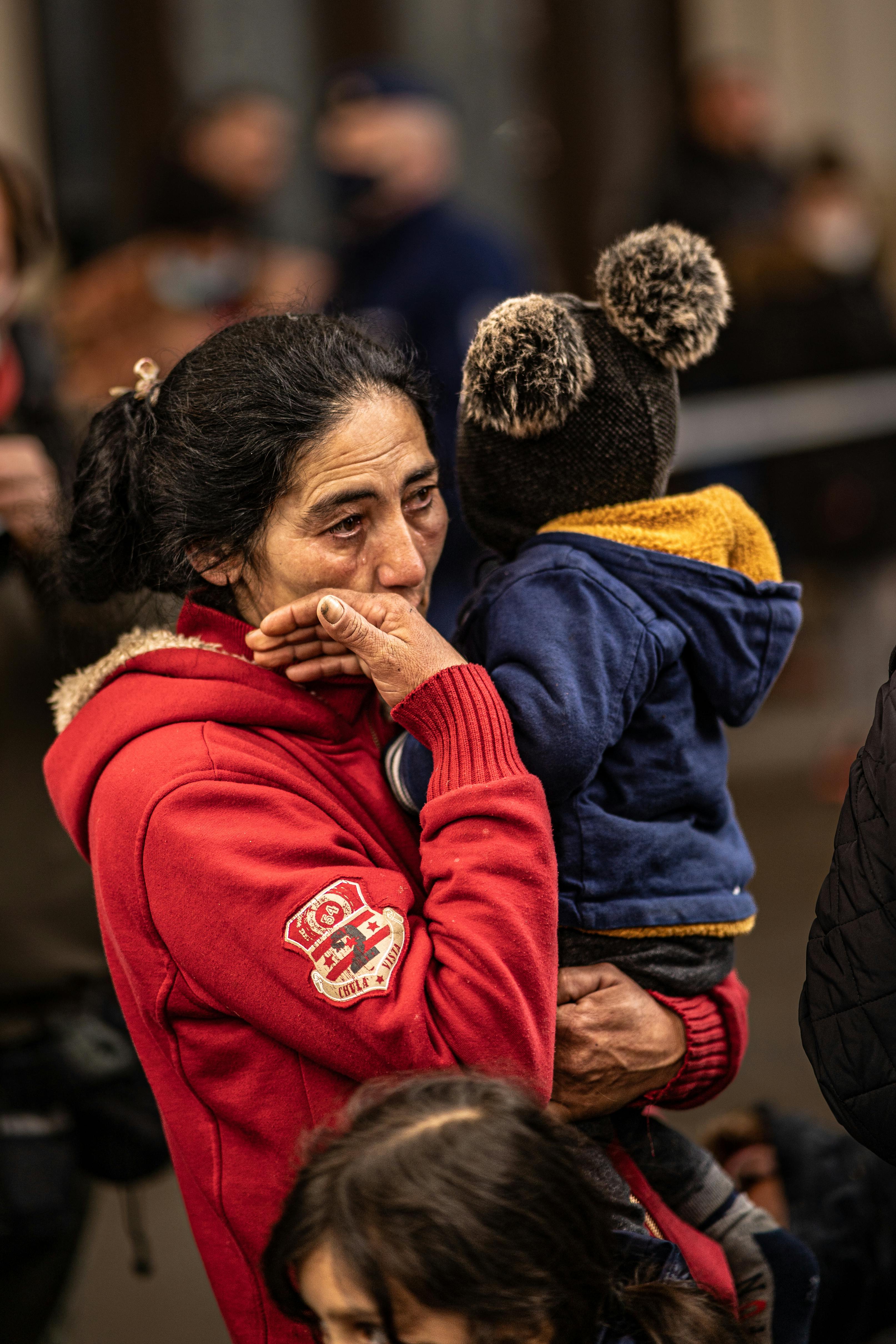 Crying Mother carrying her Child · Free Stock Photo