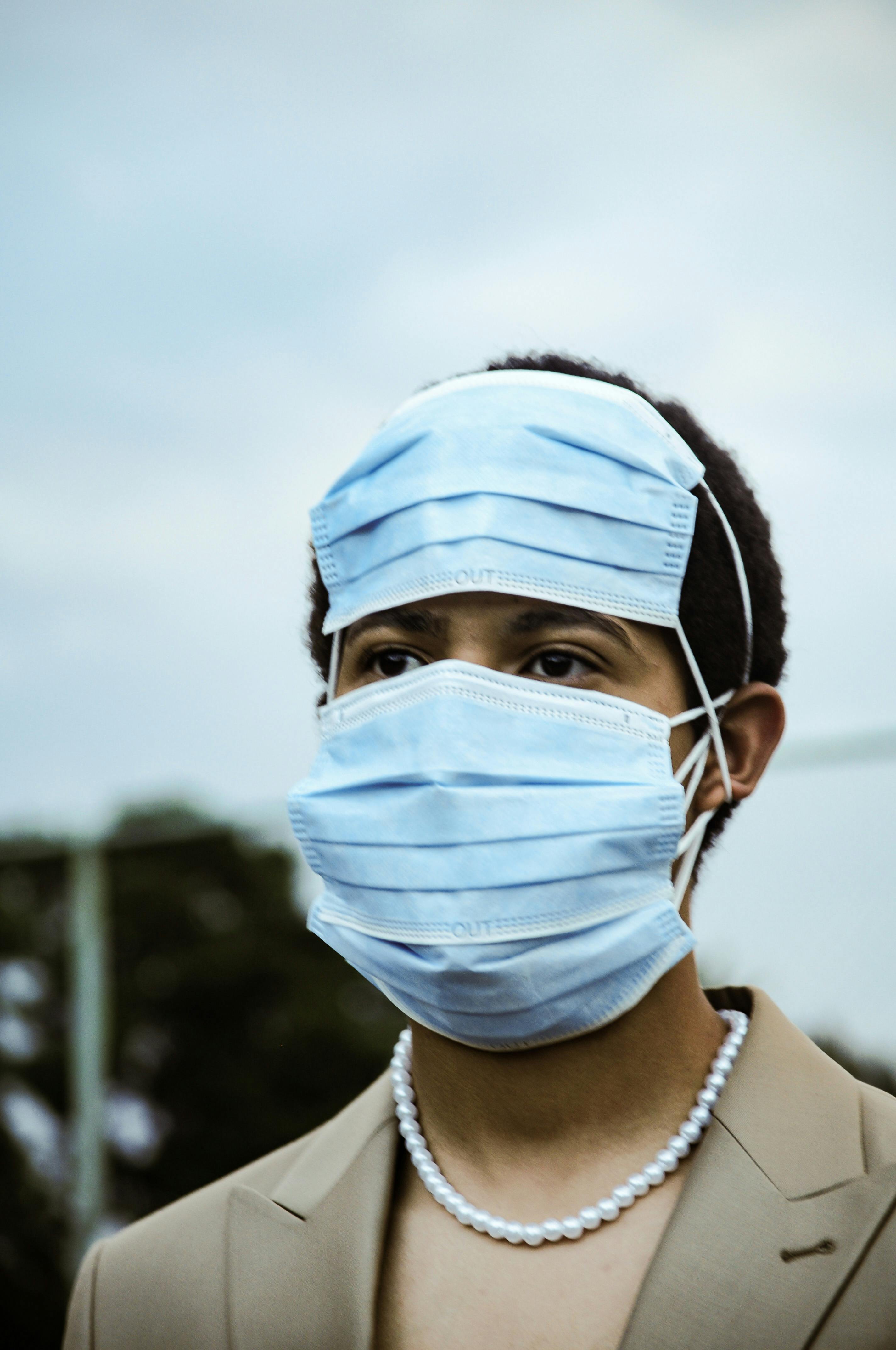 A Person Wearing a Face Mask Covered with a Net Fabric · Free Stock Photo