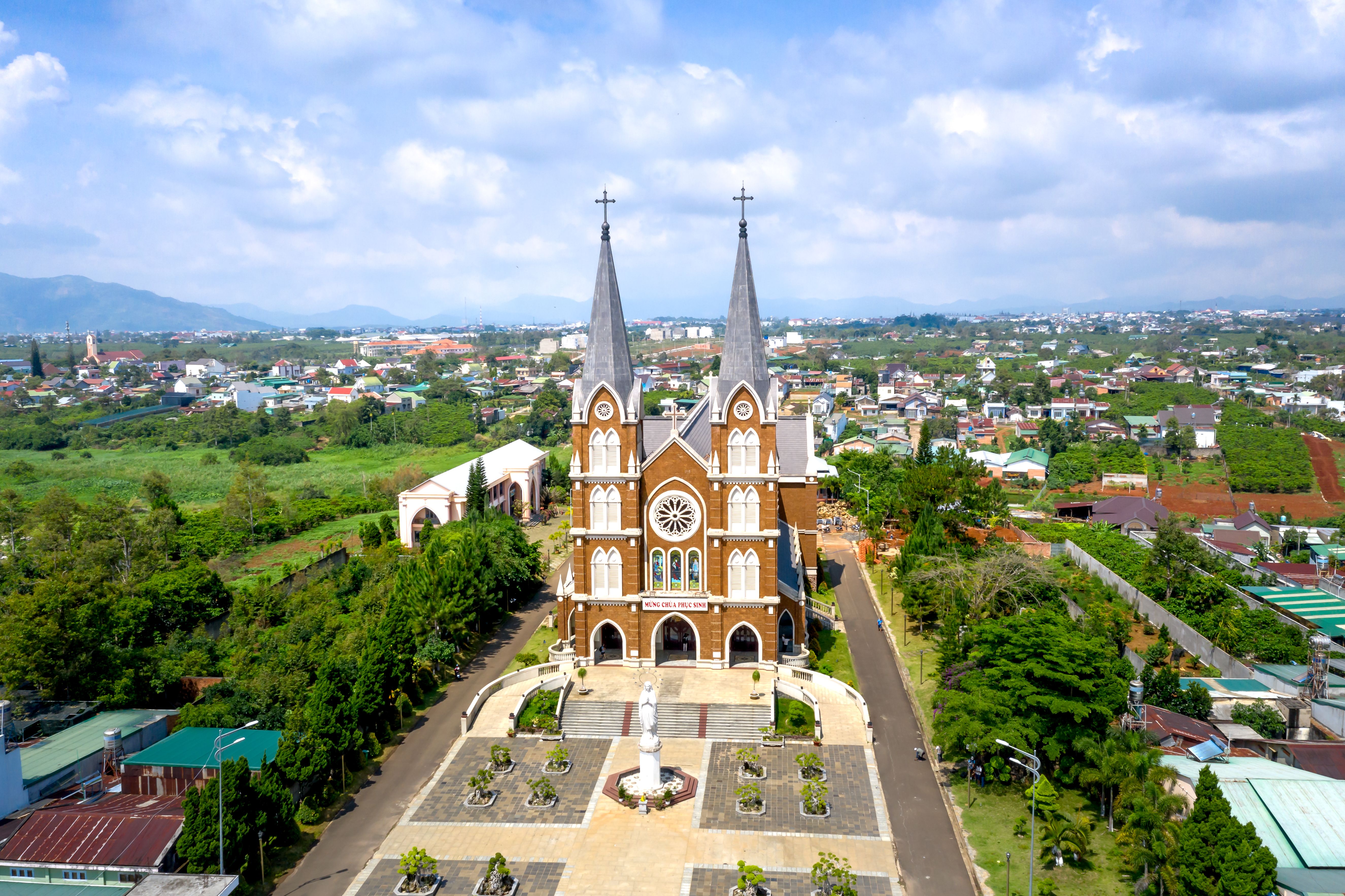 Aerial View of Church Building and Tower Under Blue Sky with White ...