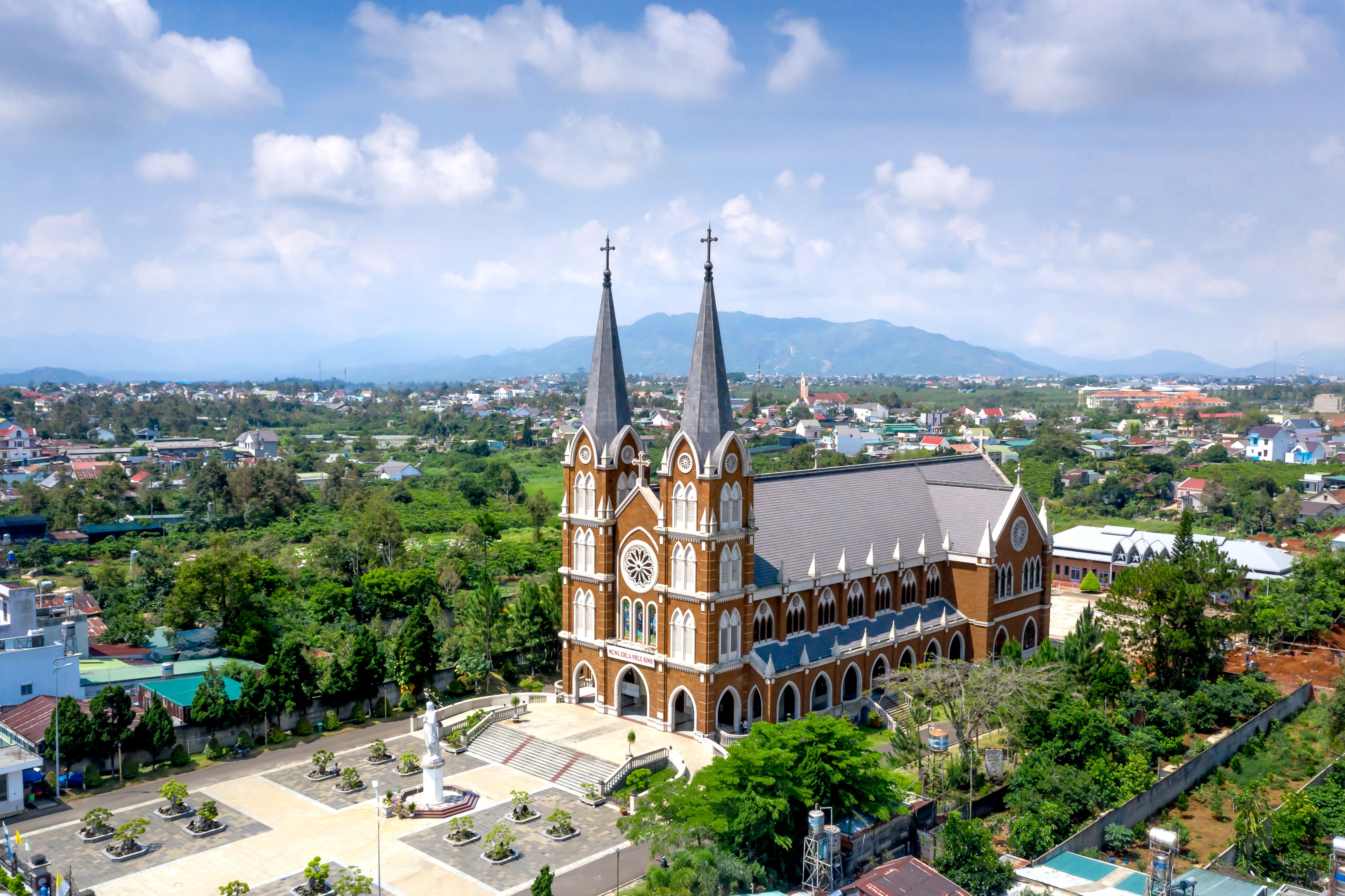 Aerial View of Church Building and Tower Under Blue Sky with White ...