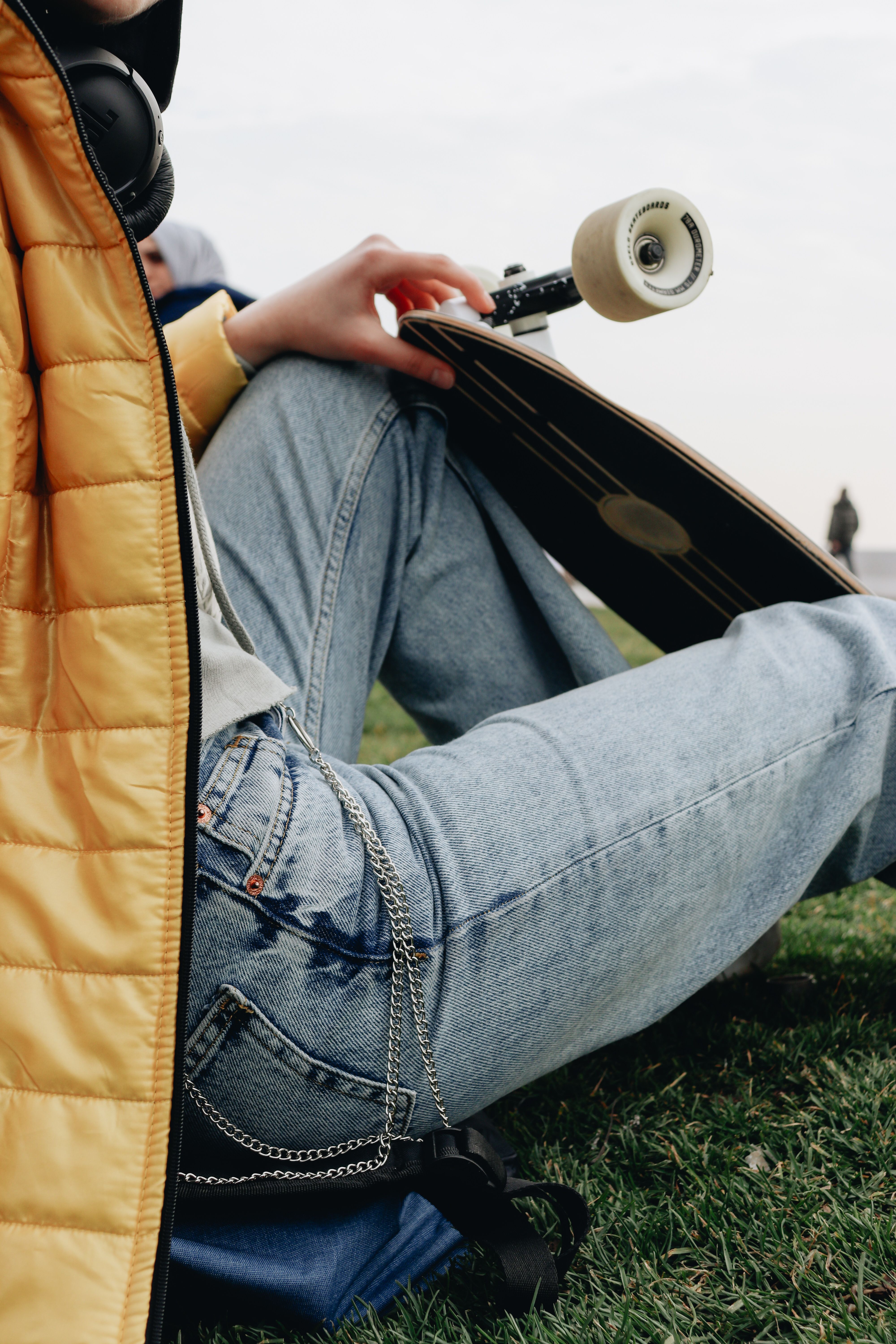 A Person Wearing Denim Jeans Sitting on Grass · Free Stock Photo