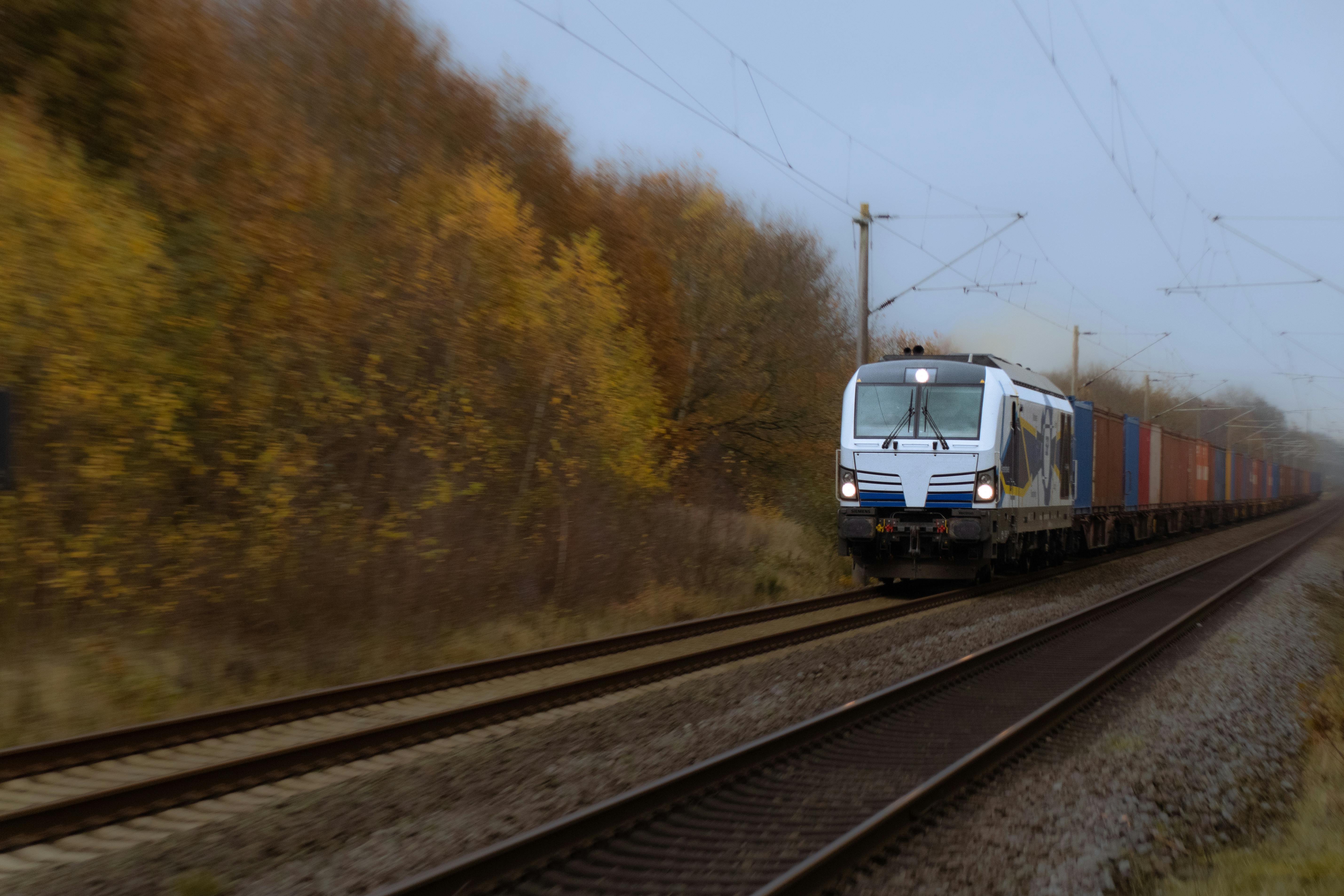Red And Blue Train On Railroads · Free Stock Photo