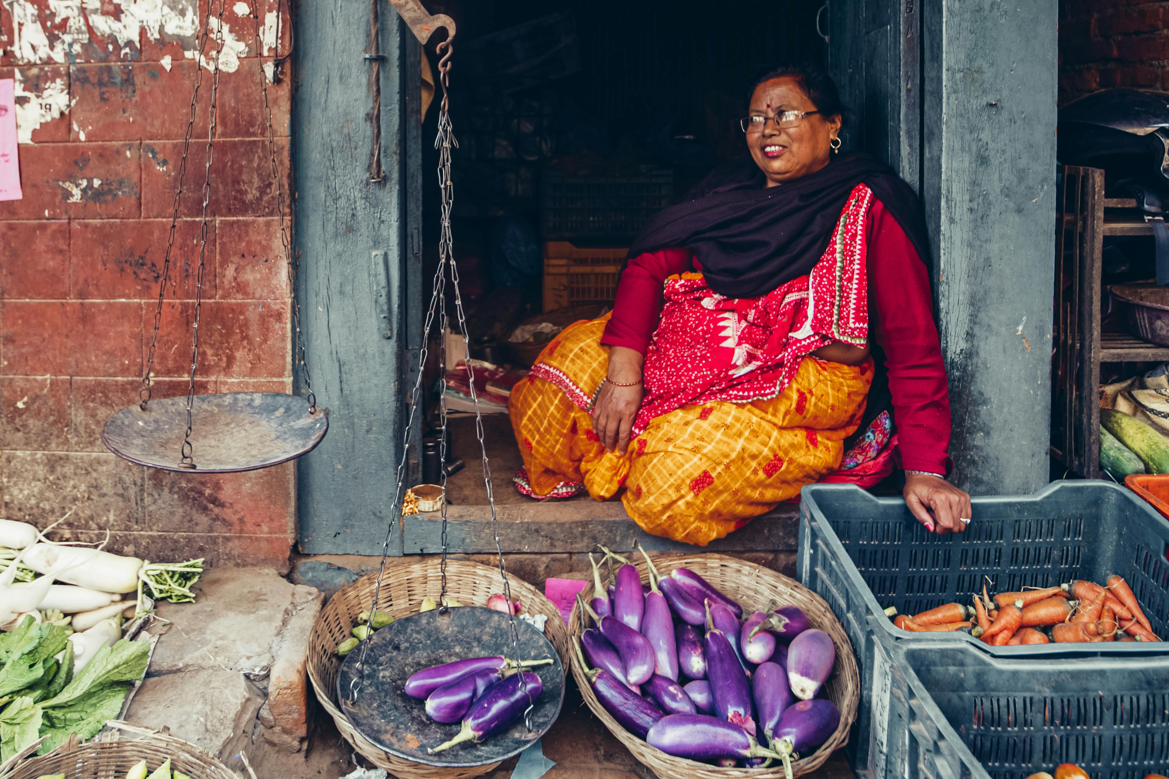 Female Merchant sitting on her Store · Free Stock Photo