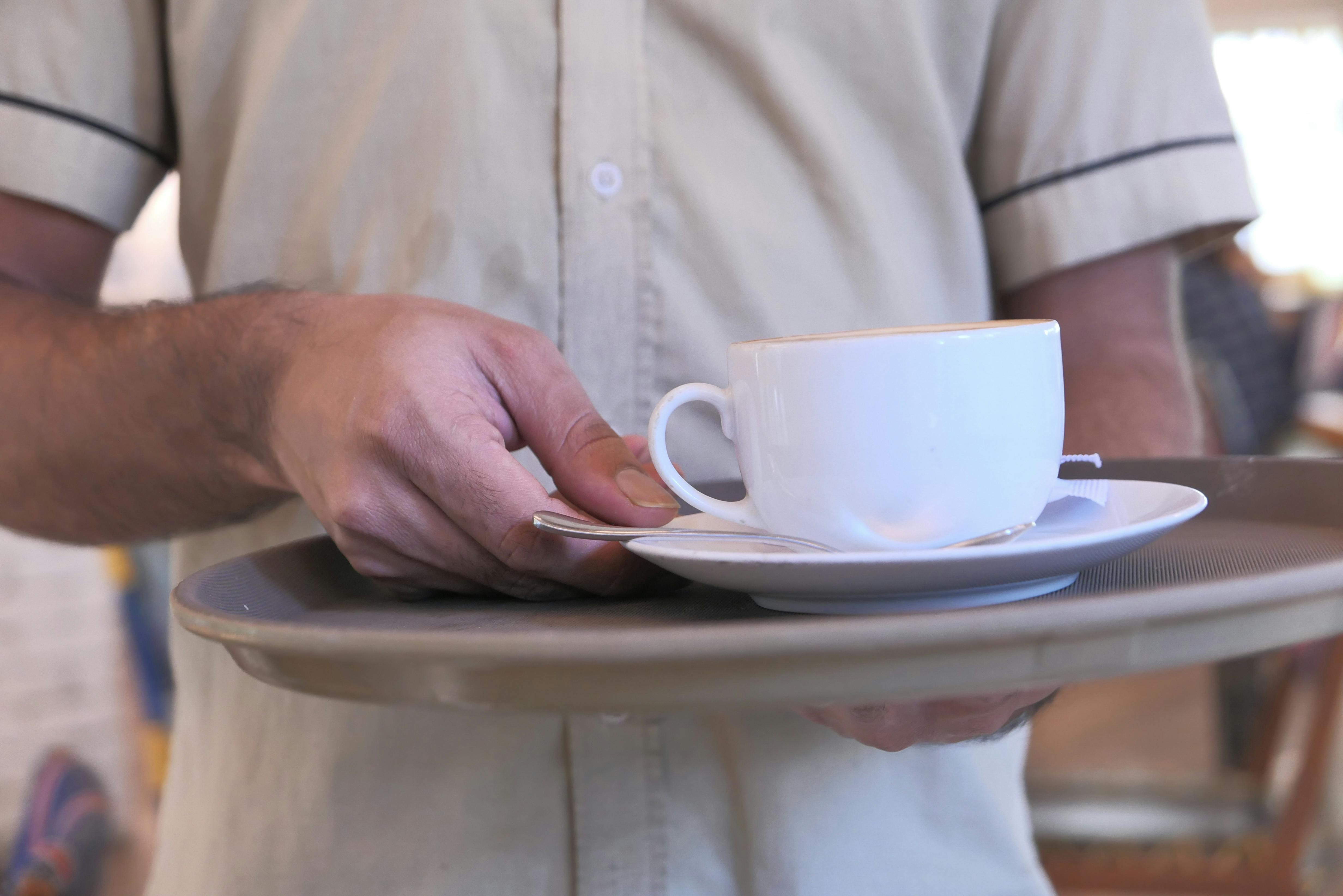 Waiter serves Coffee on Table · Free Stock Photo