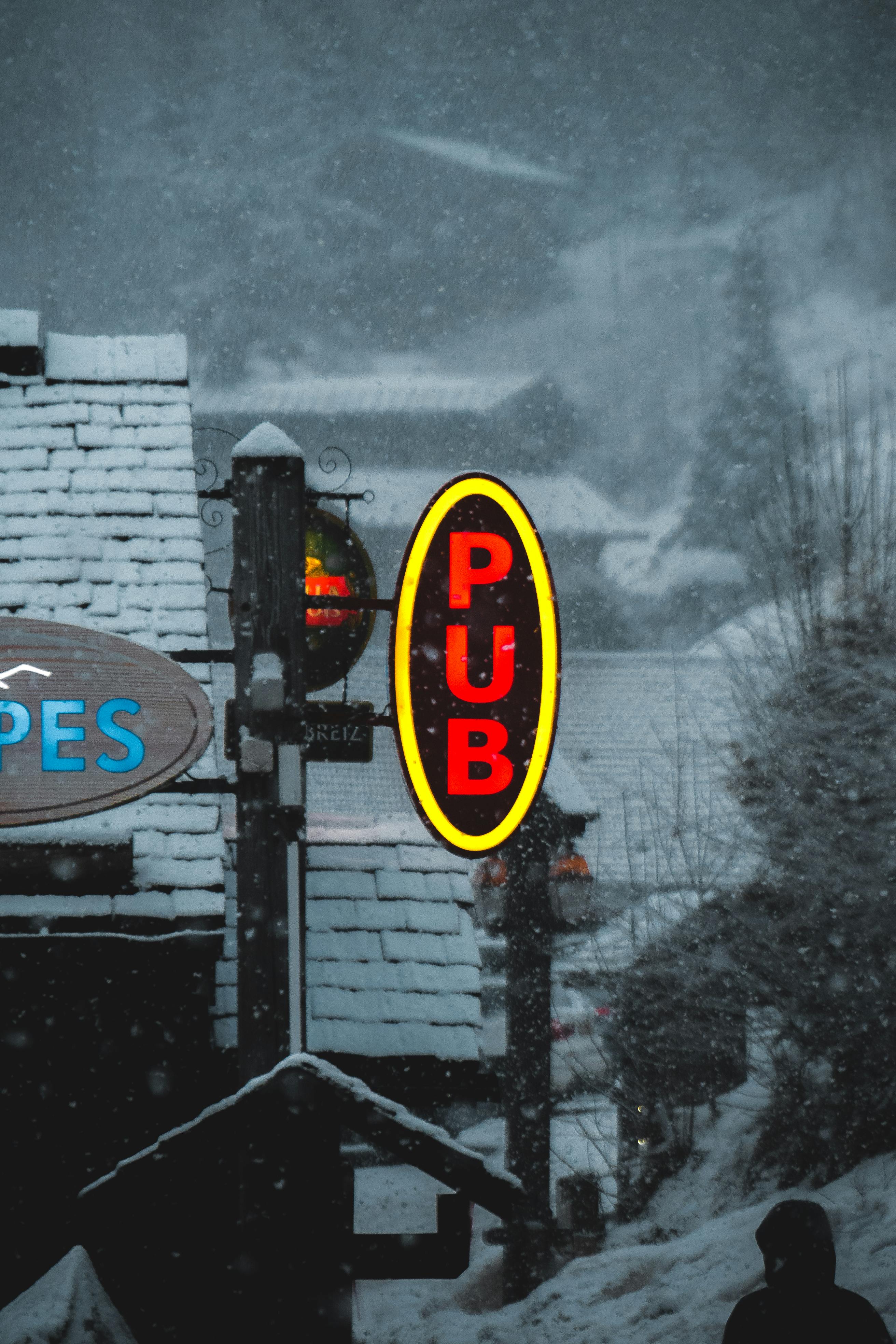 Lighted Neon Signage During Snowfall · Free Stock Photo