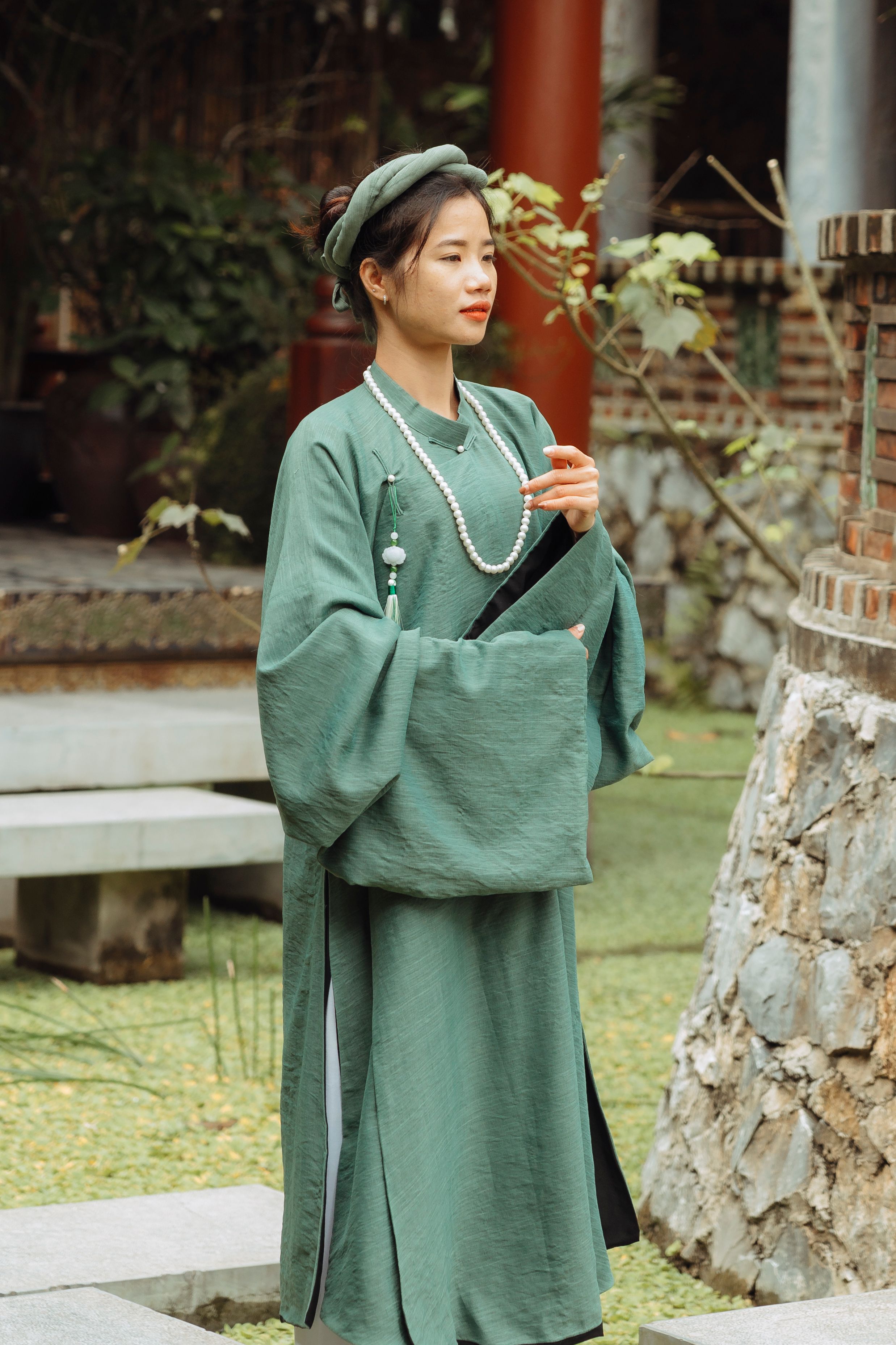 Young Woman Wearing a Traditional Hanfu Dress Dancing in a Garden ...