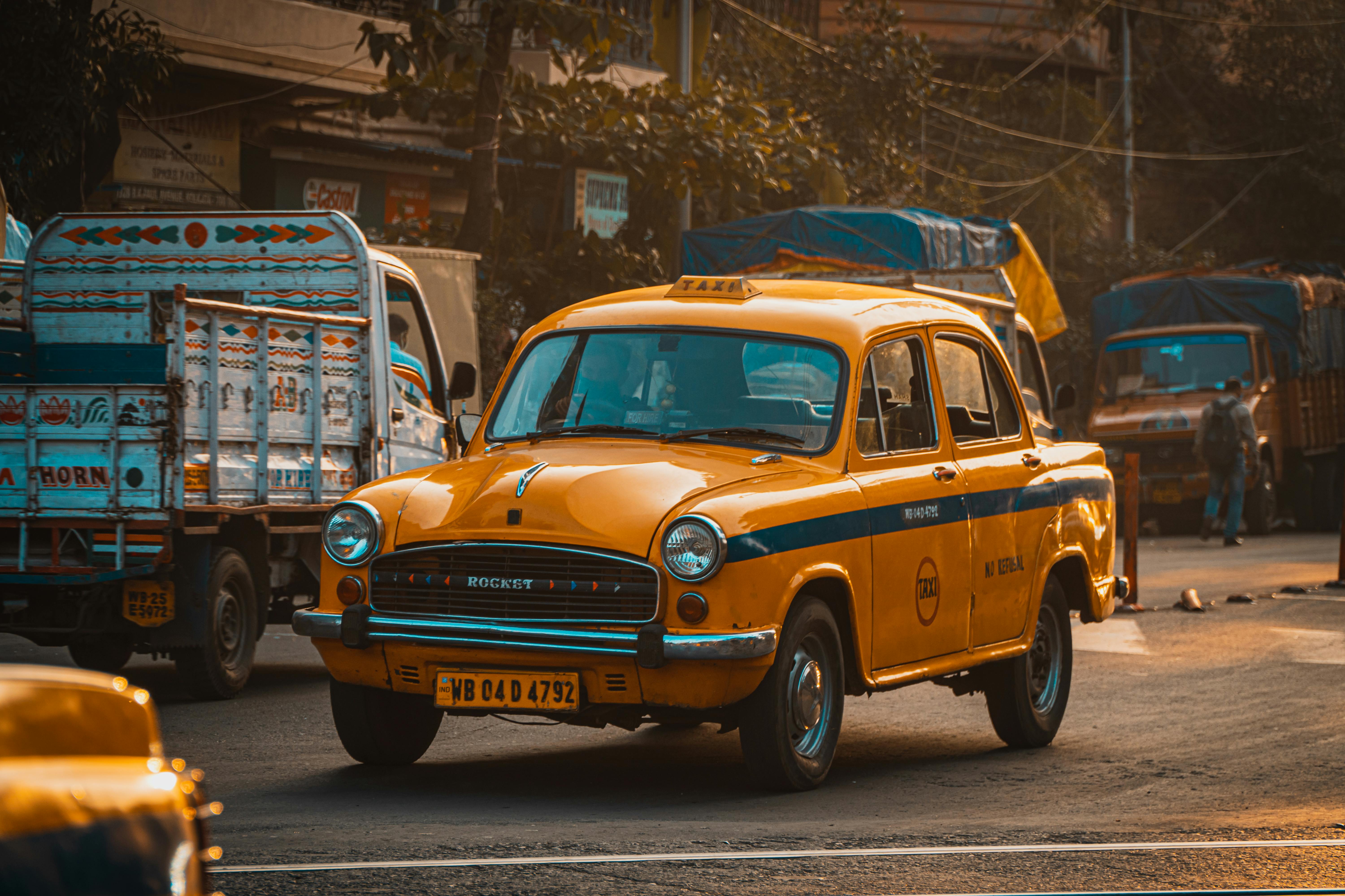 Photo of Yellow Taxi on Narrow Street · Free Stock Photo