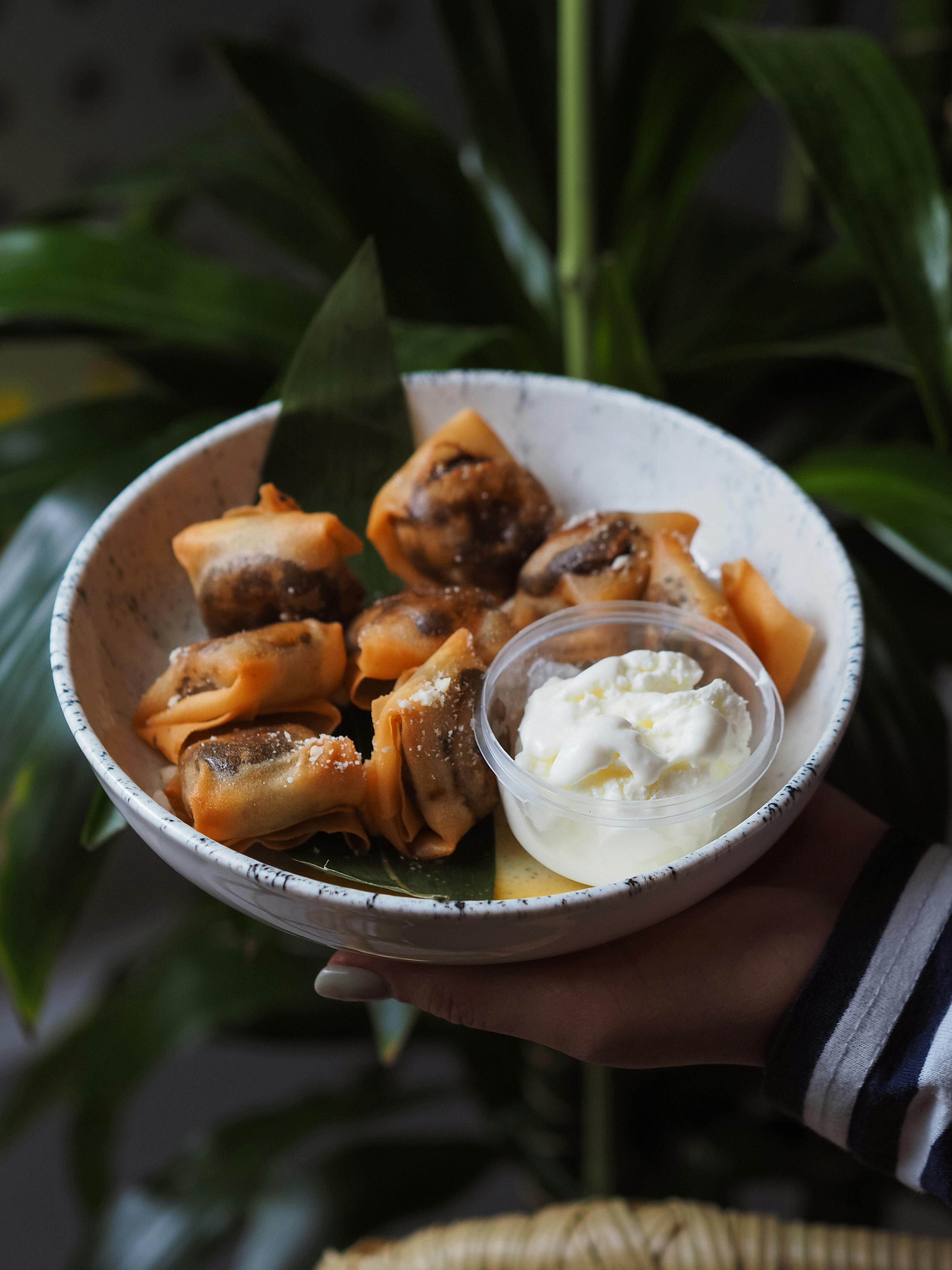 Hand Squeezing a Lemon on a Fish · Free Stock Photo