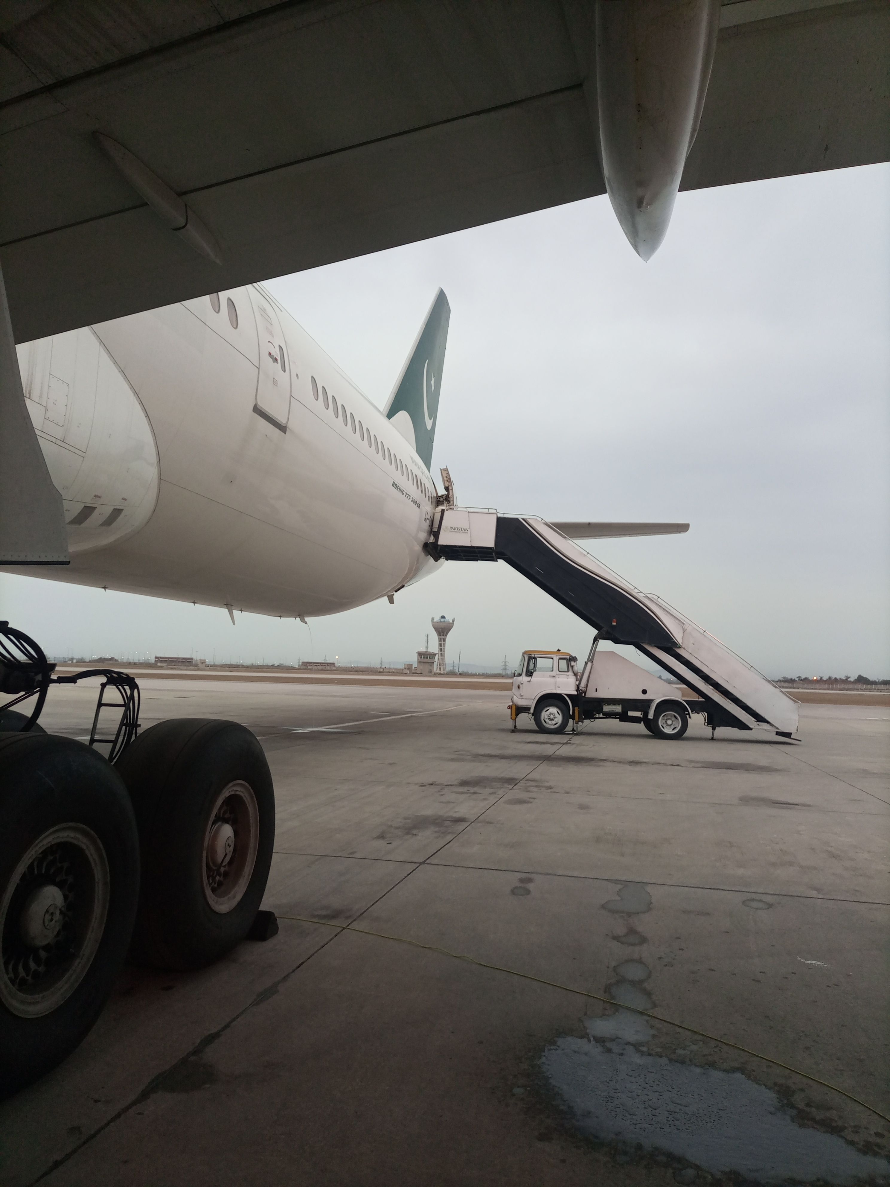 A Pushback Tractor Near the Airplane · Free Stock Photo