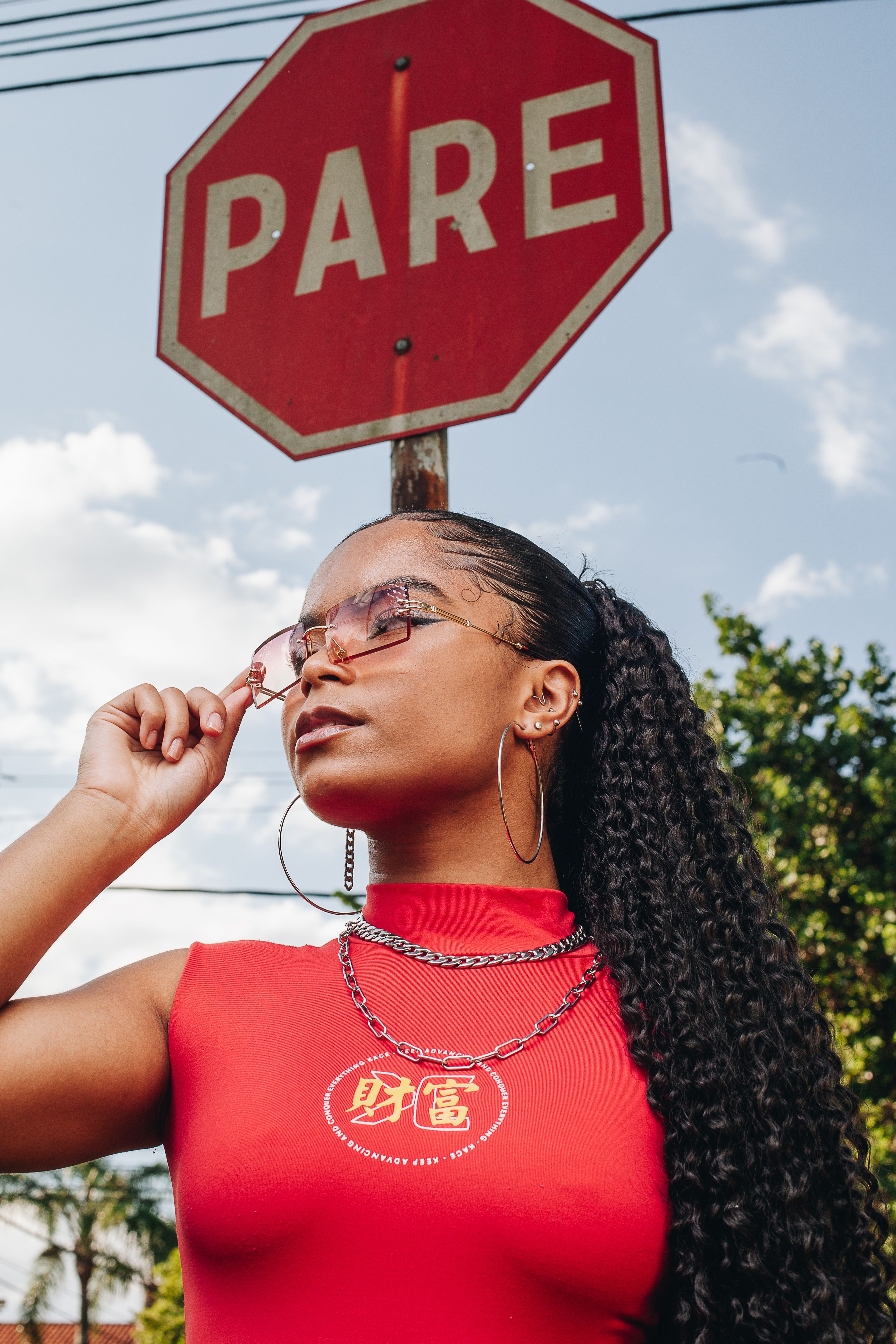 A Woman Standing near Traffic Sign · Free Stock Photo
