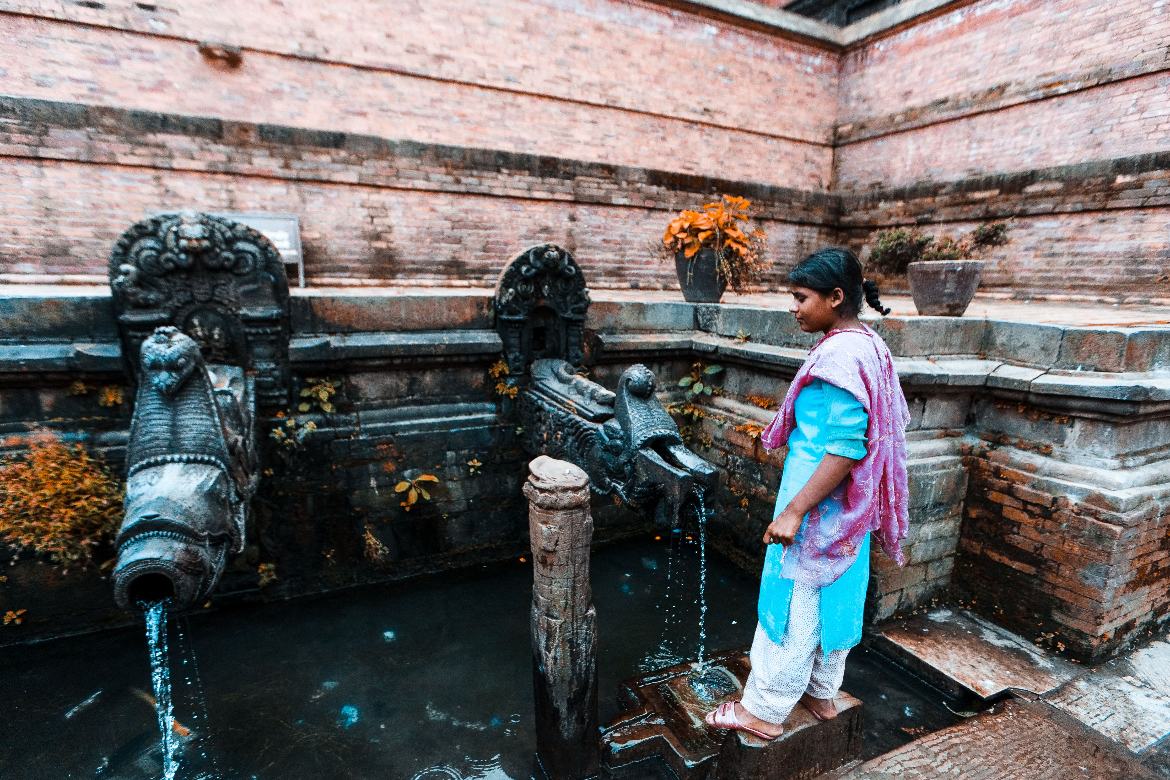 A Woman Standing in a Temple · Free Stock Photo