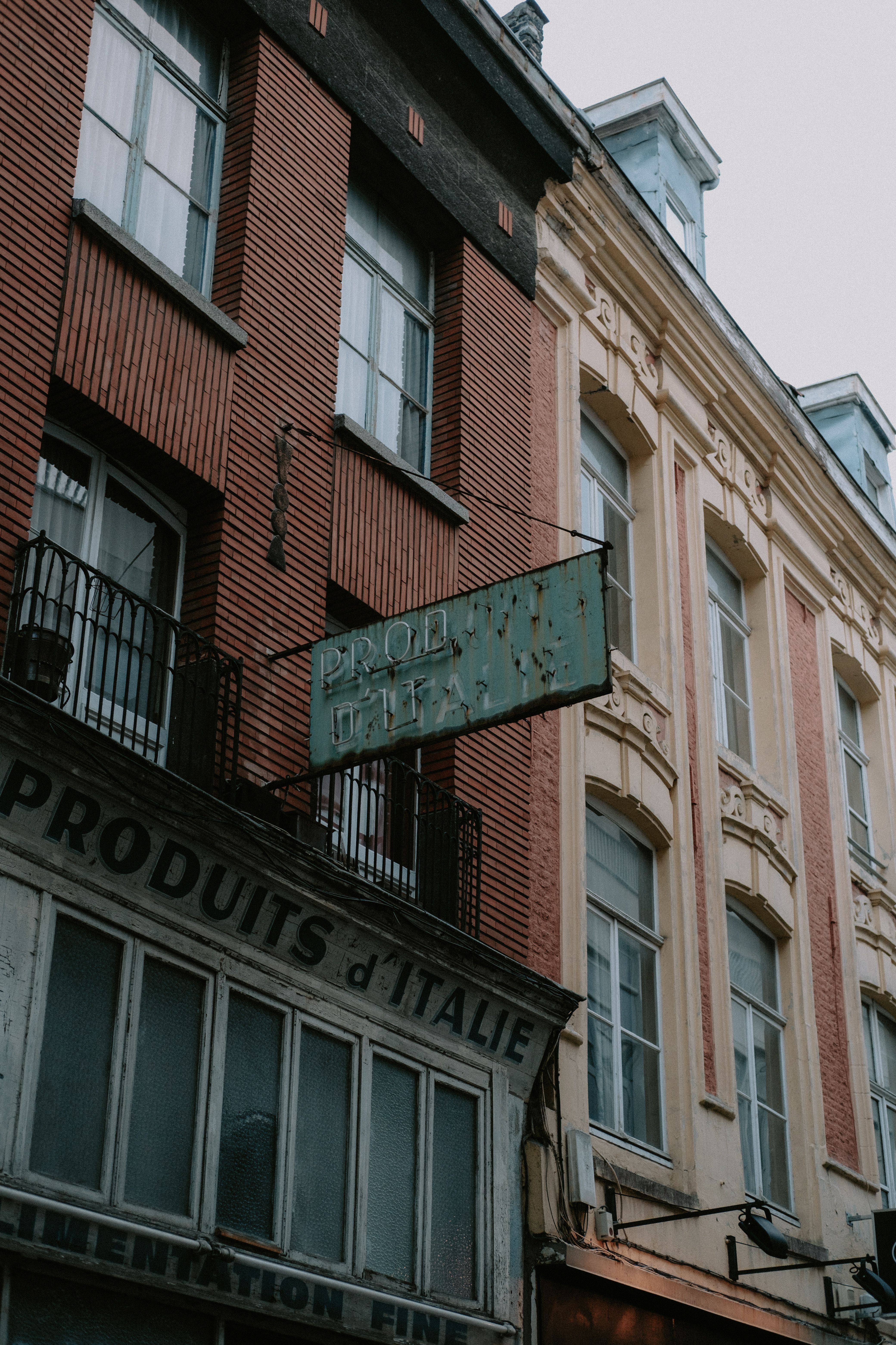 Low Angle Shot of an Old Signage in a Brick Building · Free Stock Photo