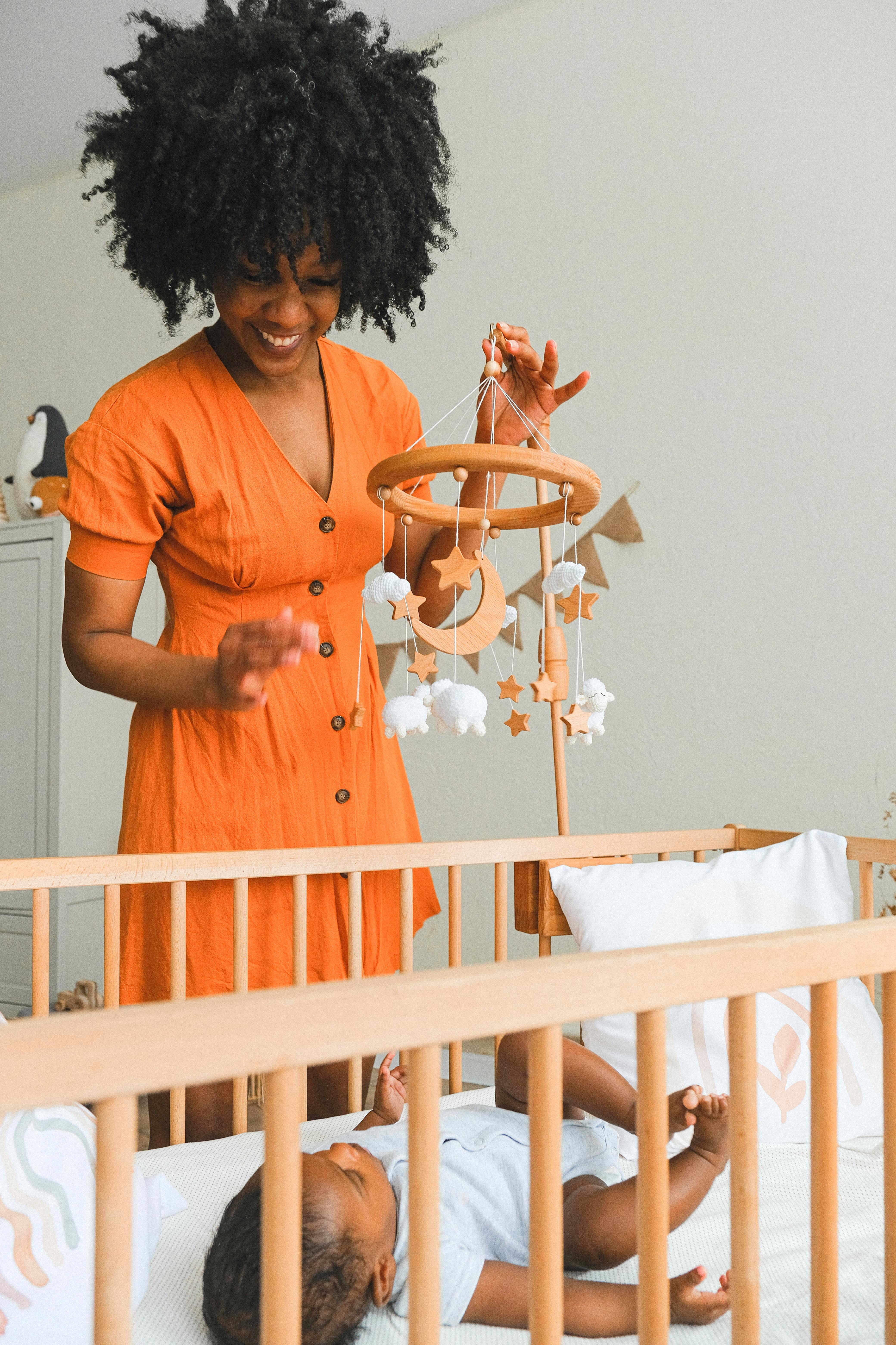 Man and Woman Building a Baby Crib and Laughing · Free Stock Photo