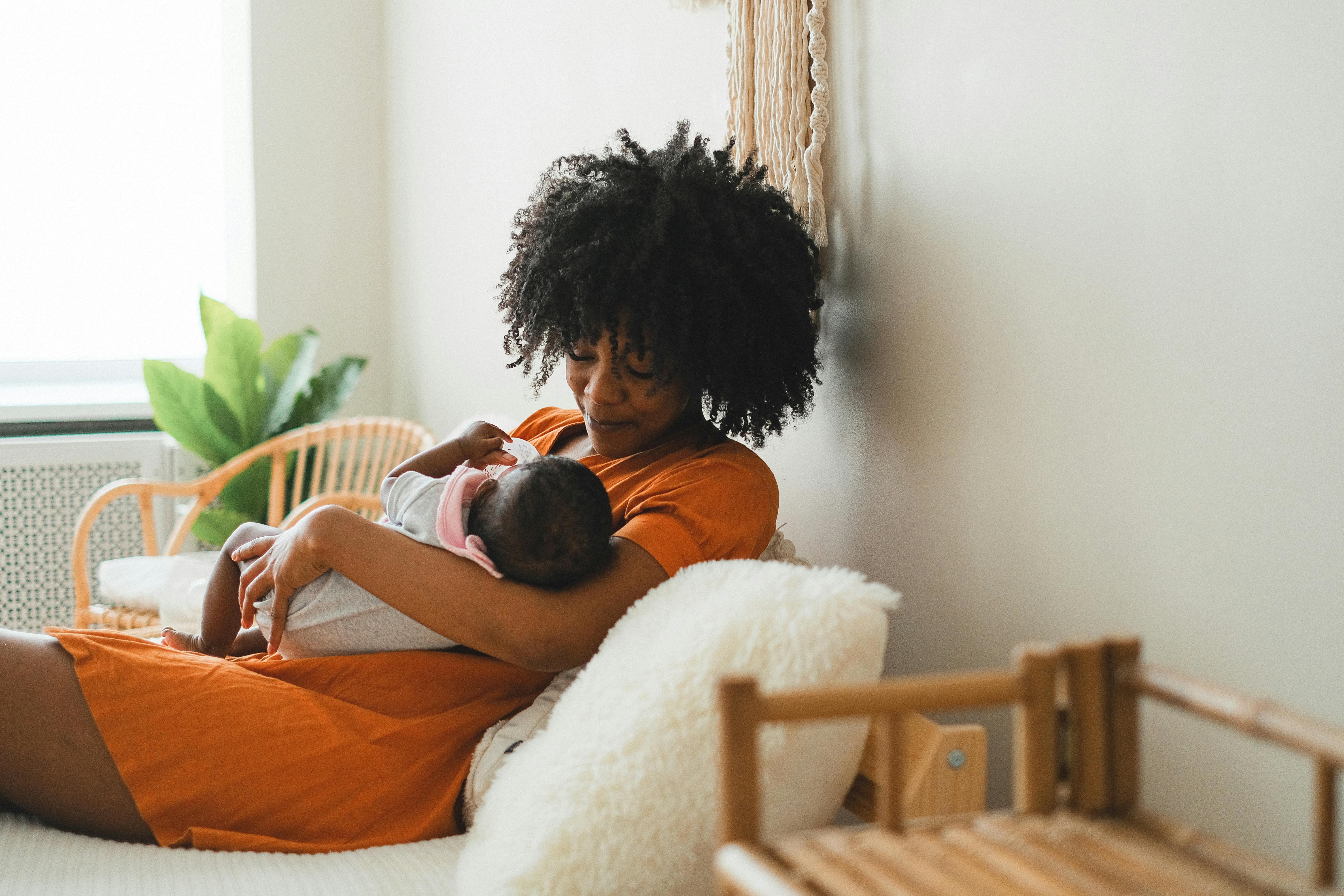 A Woman Cuddling her Baby · Free Stock Photo