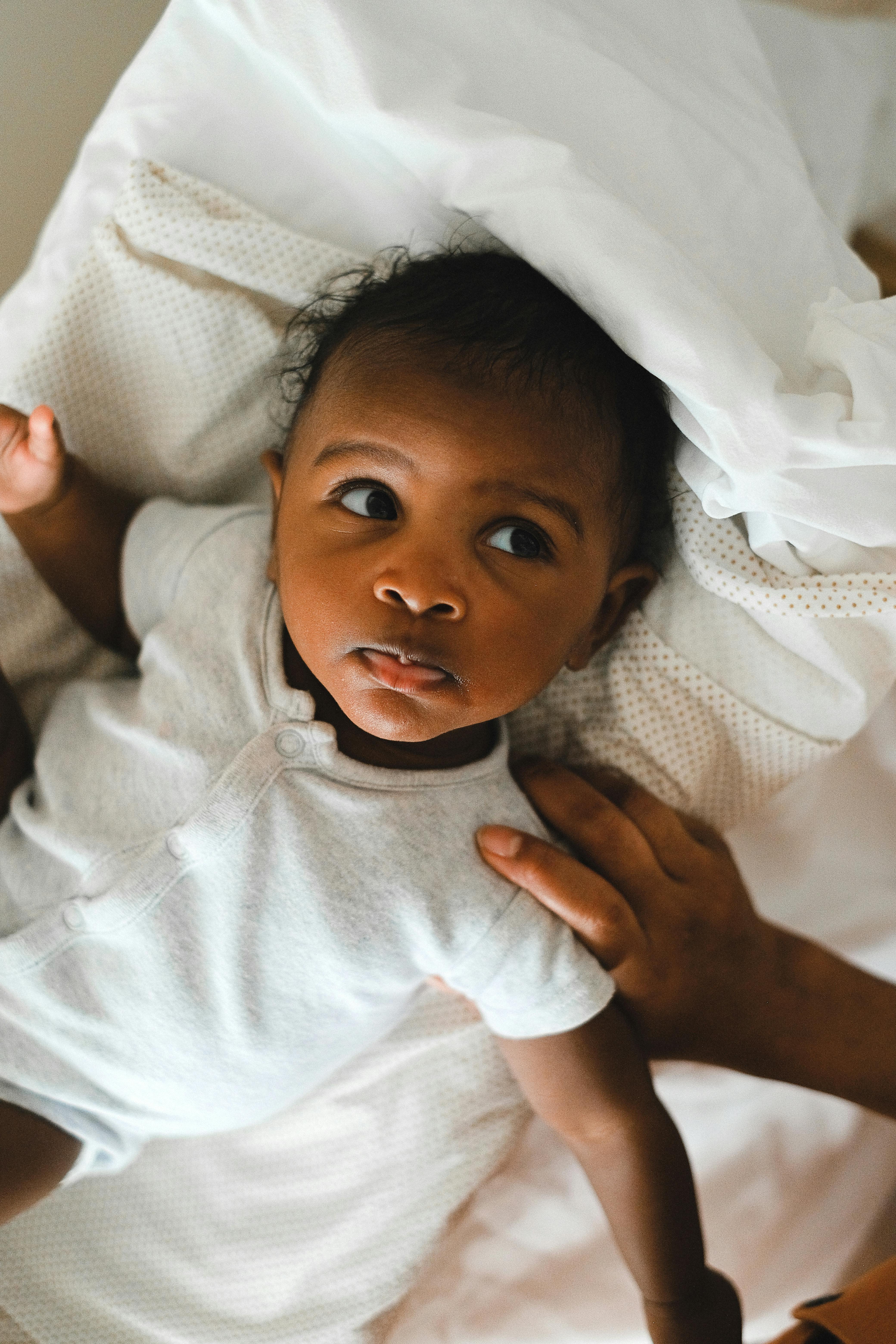 Selective Focus Photo of Little Girl Lying Forward on the Bed · Free ...