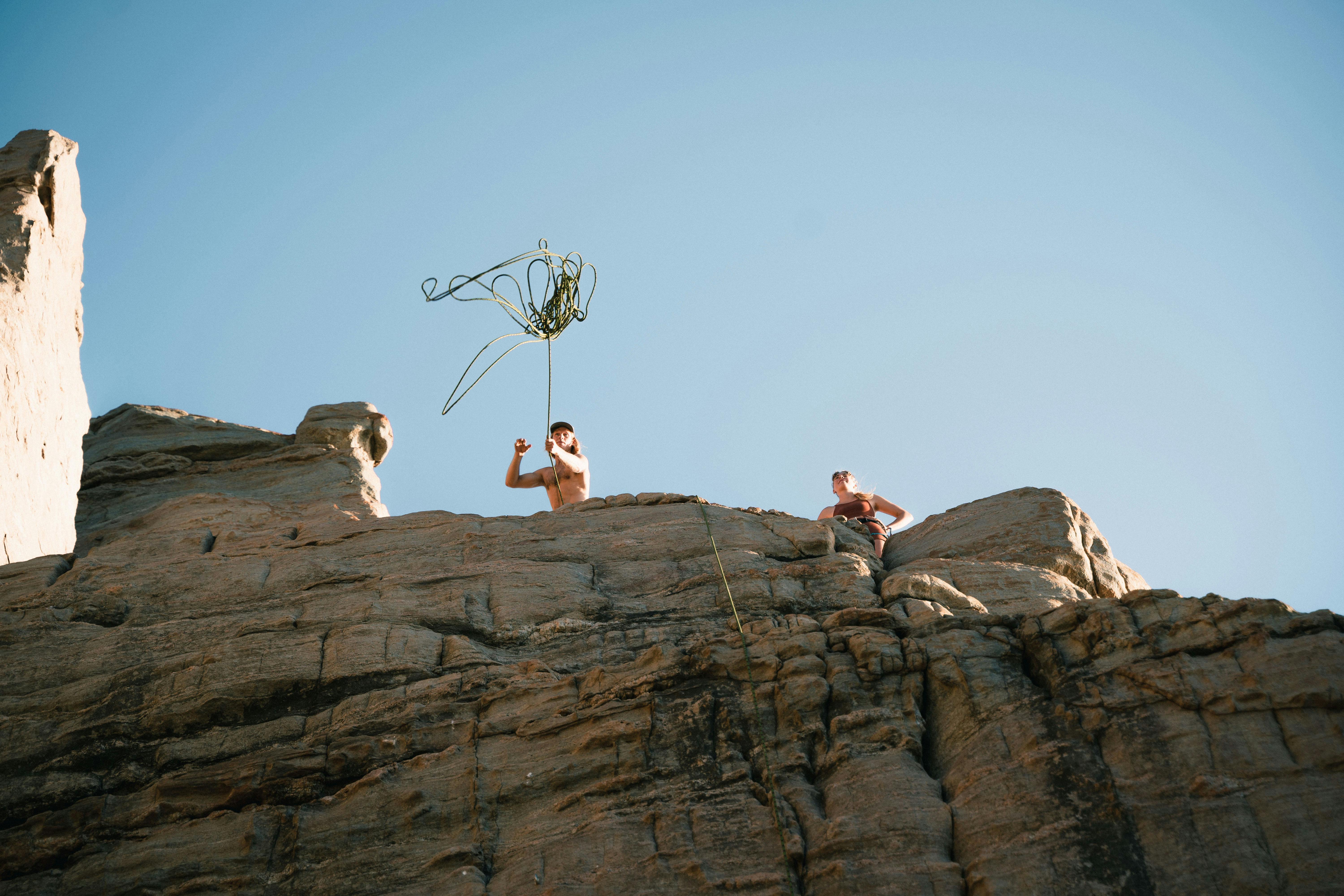 A Person Throwing Rope over a Natural Rock Formation · Free Stock Photo