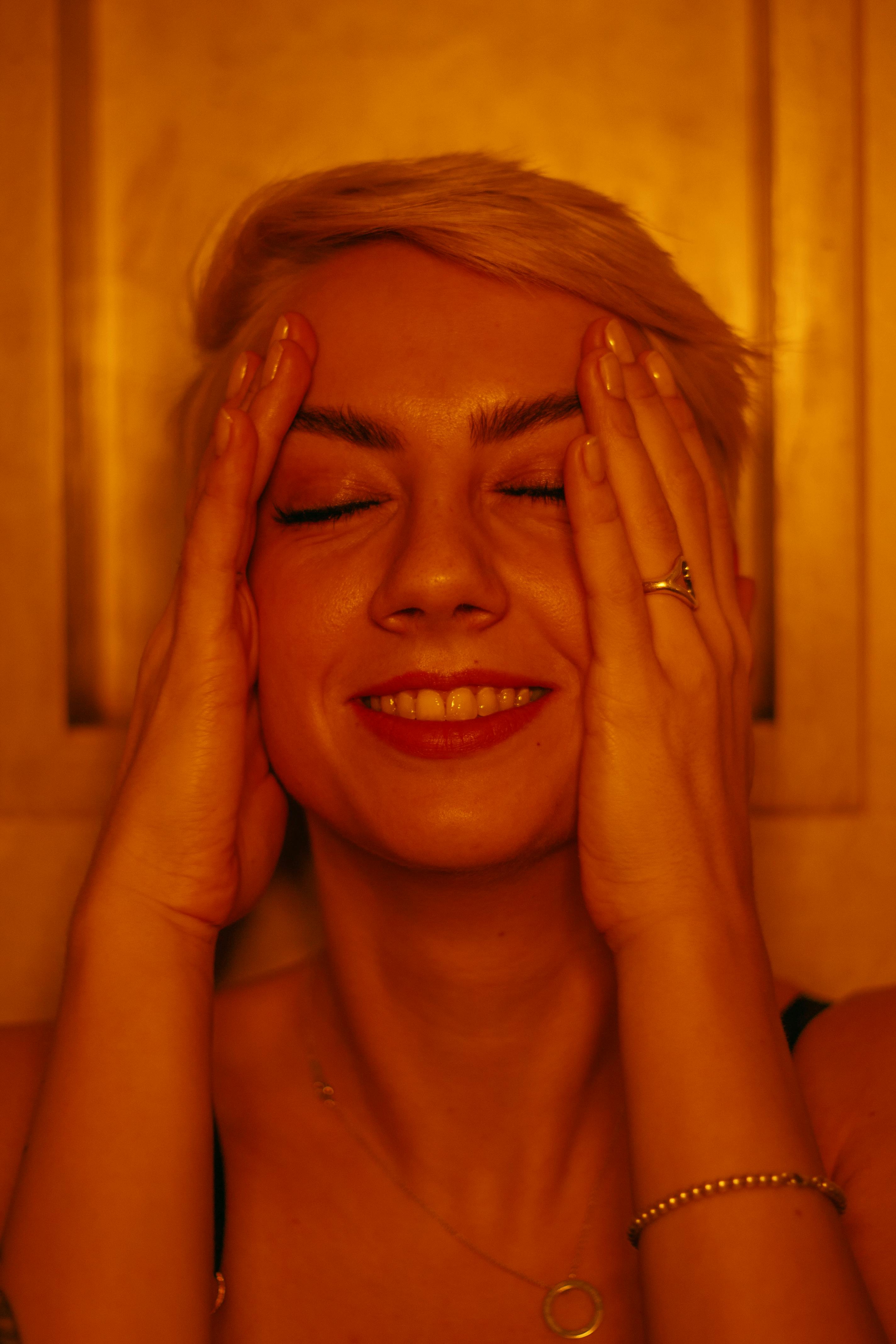 Woman with Her Hands on Her Face in Close Up Photography · Free Stock Photo