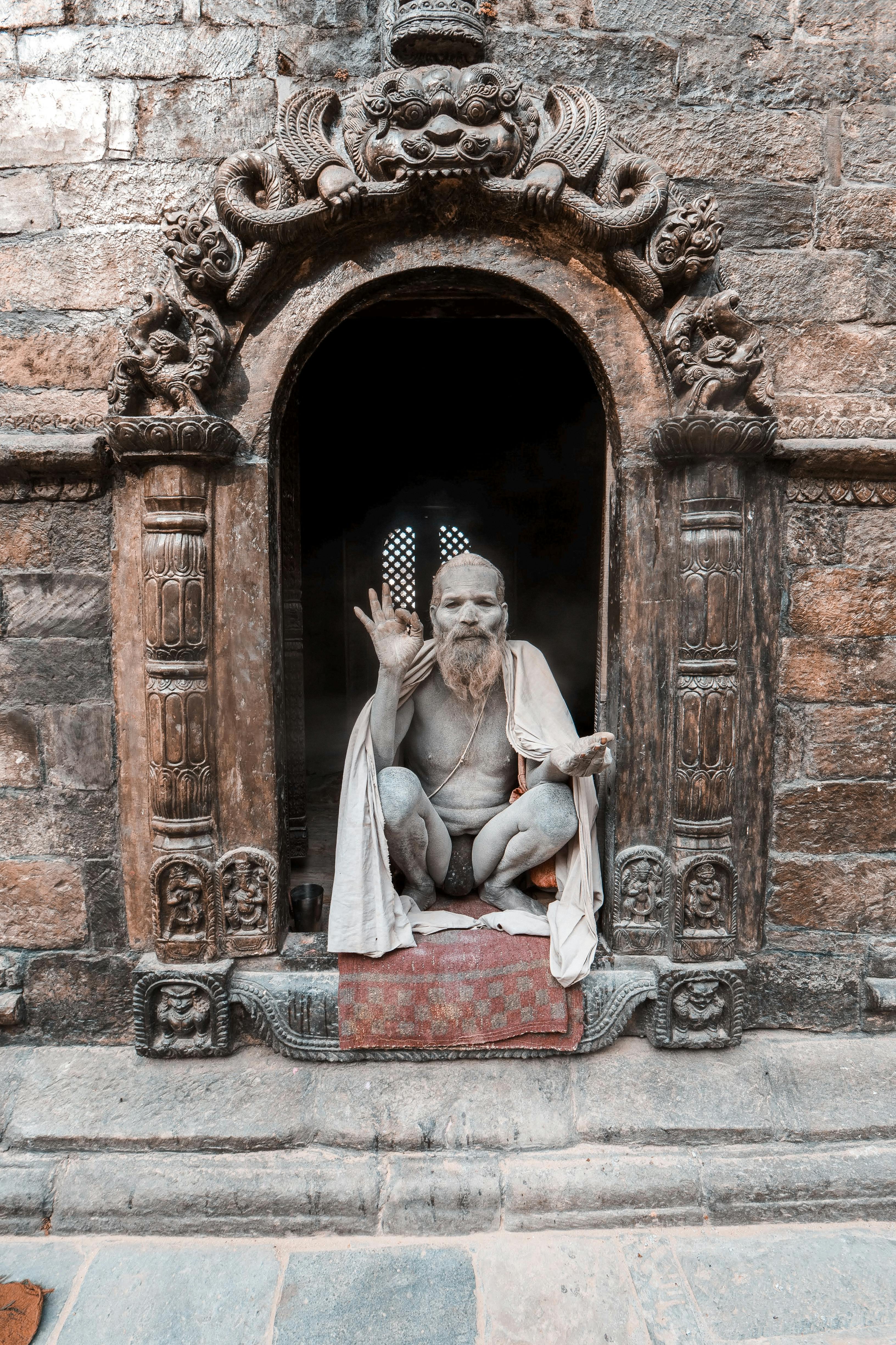 Old Yogi Man Crouching in Gate of Ancient Building · Free Stock Photo