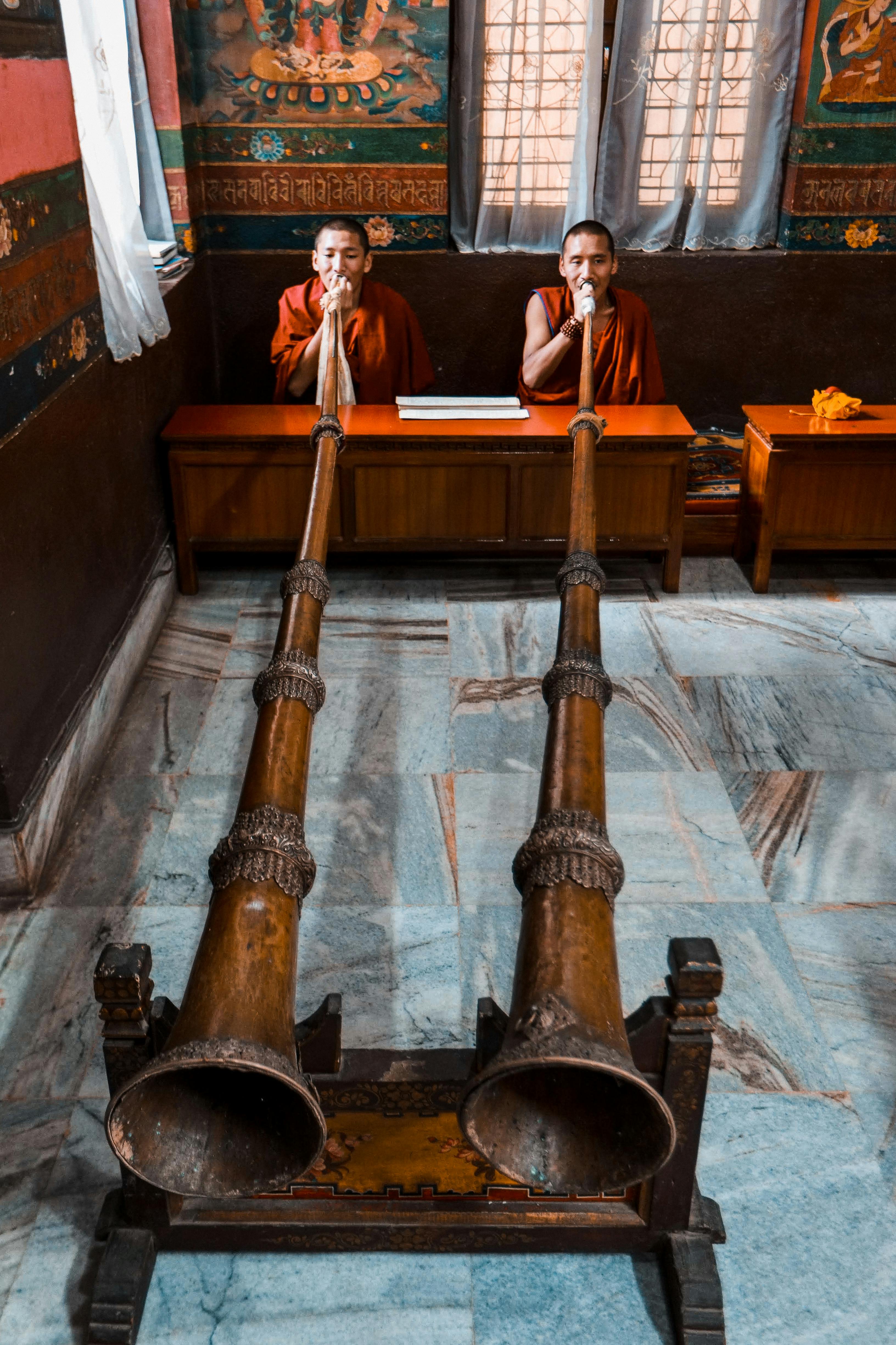 Monks with Giant Trombones · Free Stock Photo