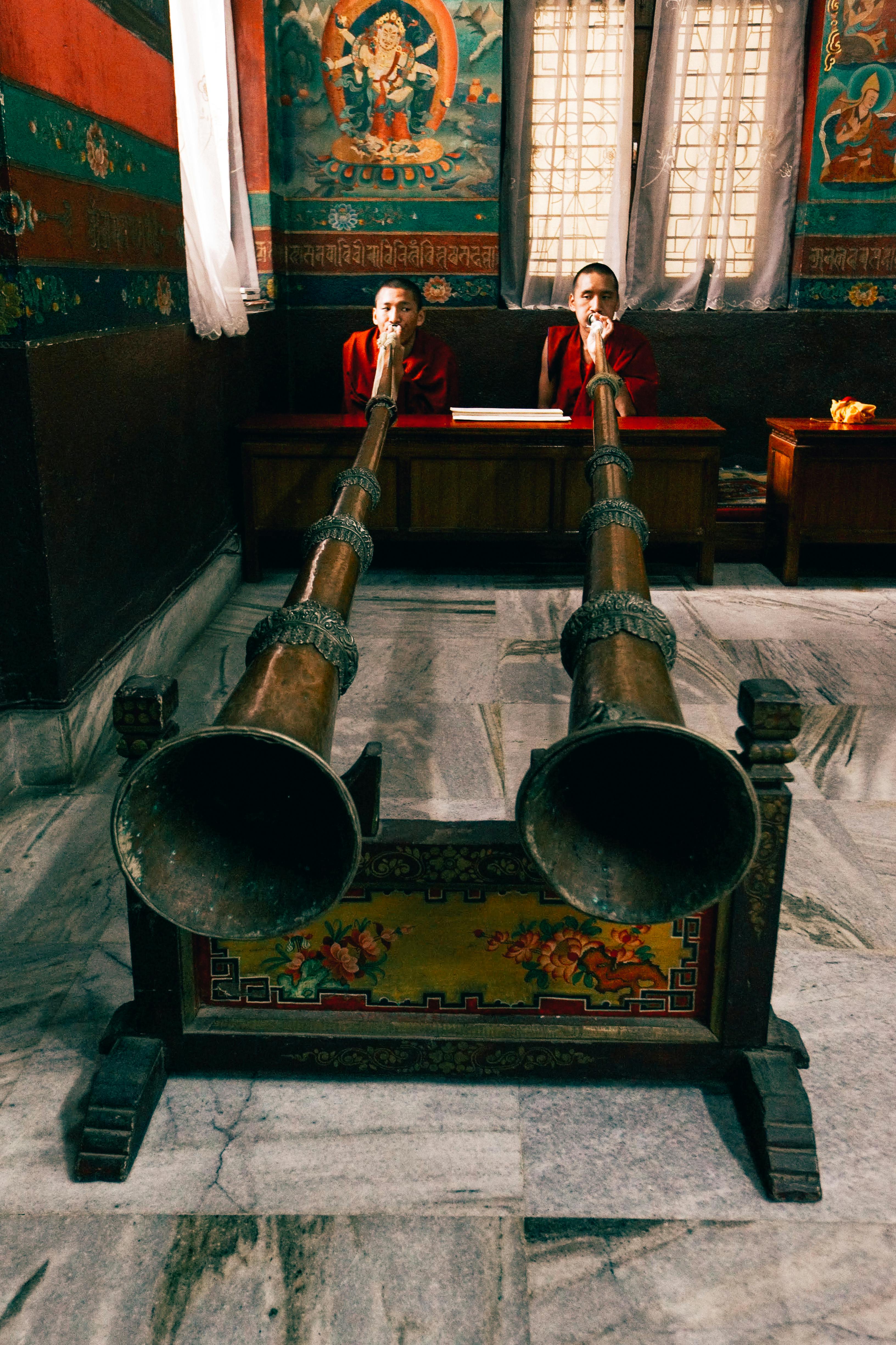 Monks Playing on Long Trumpets in a Monastery · Free Stock Photo
