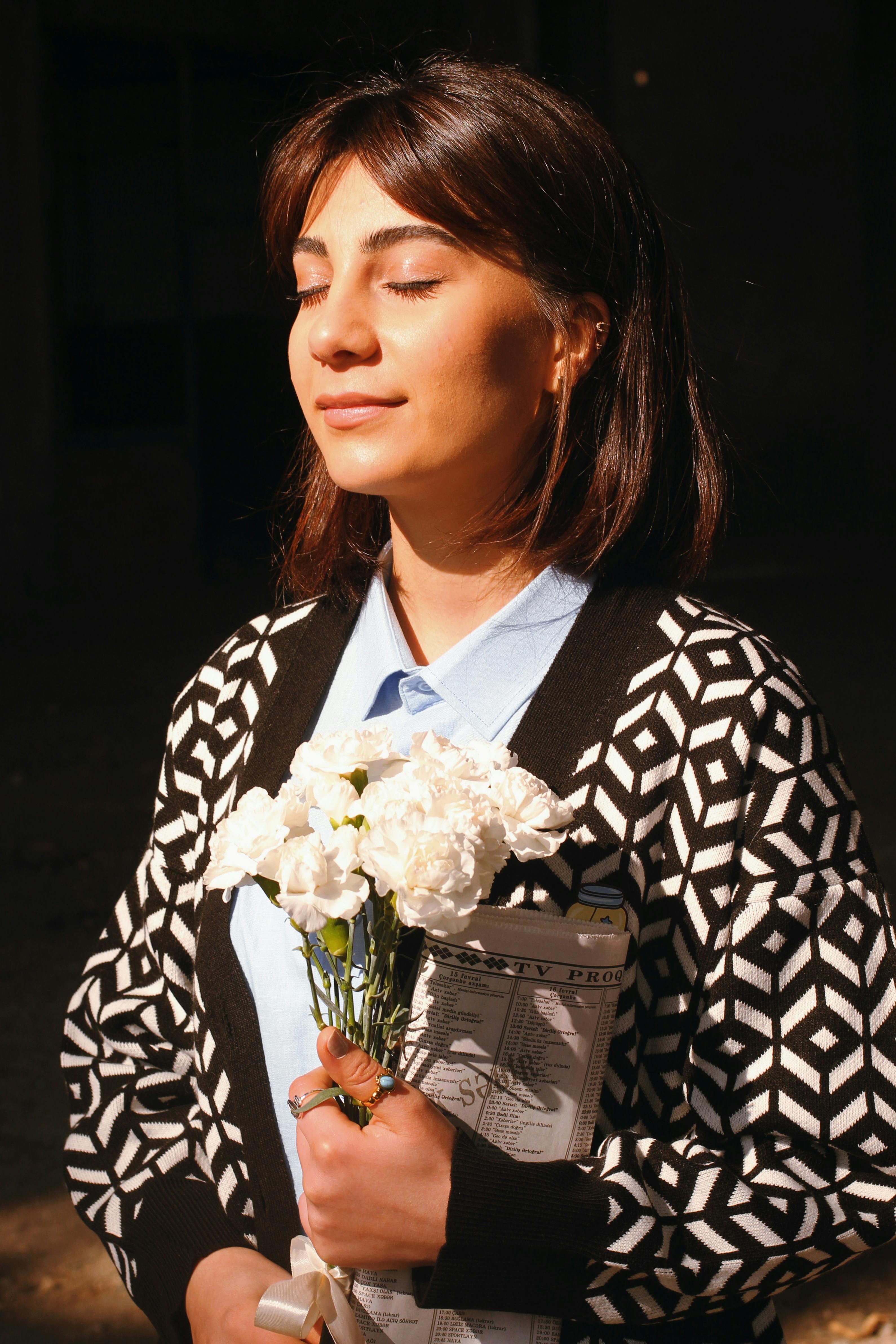 Photo of a Woman Smelling a Paper Bowl · Free Stock Photo
