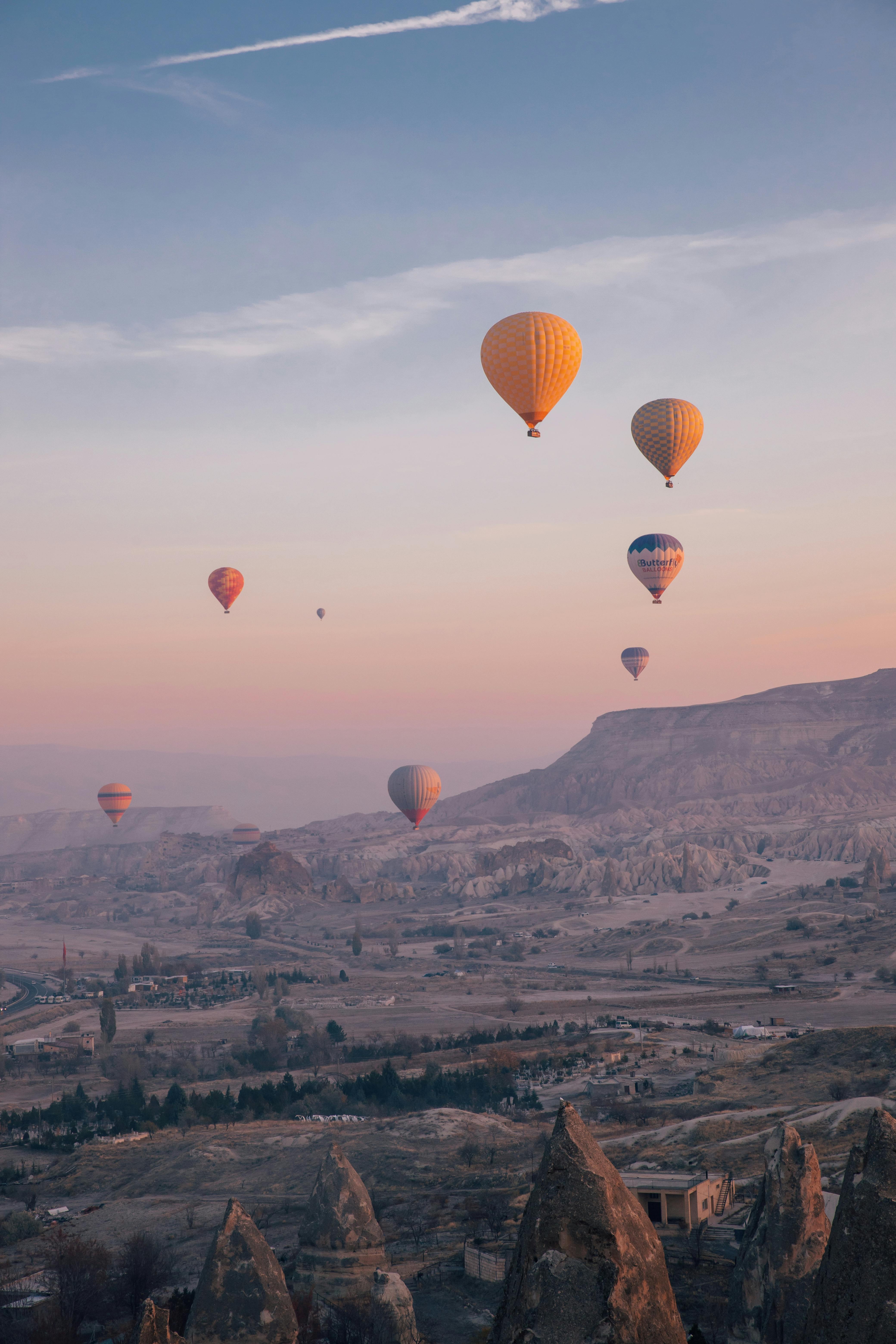 Hot Air Balloon Flying over the Rock Formation Under Blue Sky · Free ...