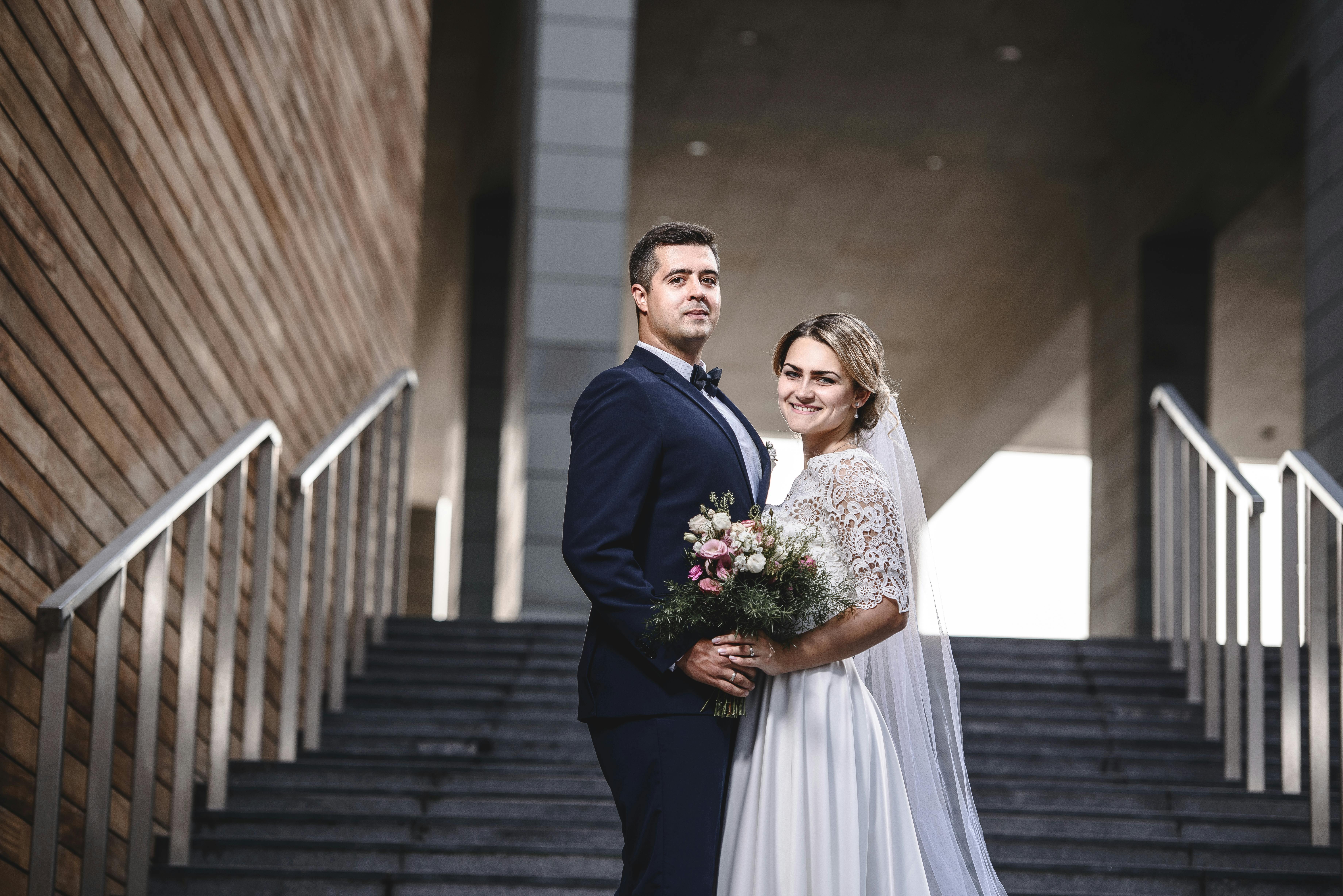 Beautiful Wedding Couple Standing on the Stairs · Free Stock Photo