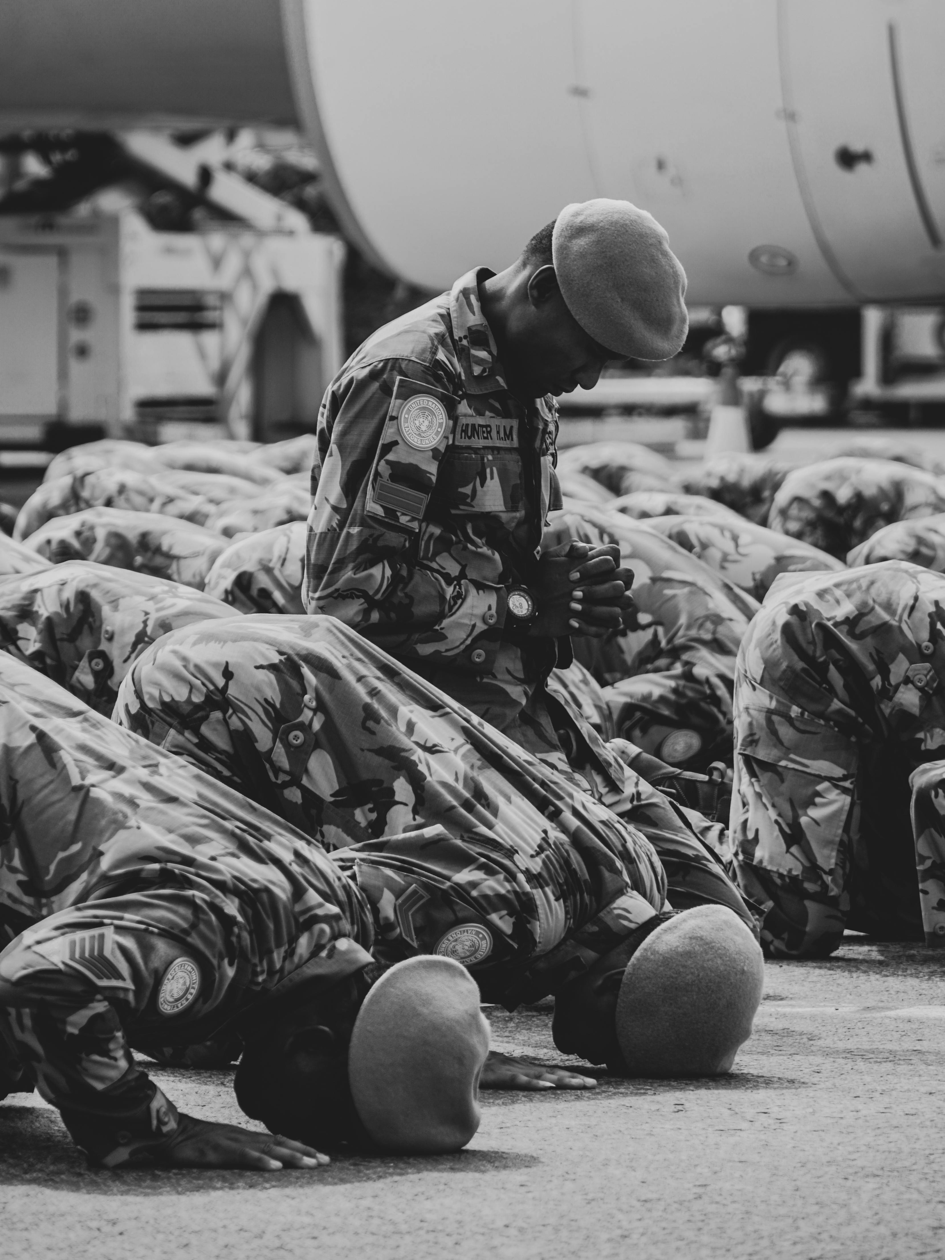 Grayscale Photo of Soldiers Bowing Down on the Ground · Free Stock Photo