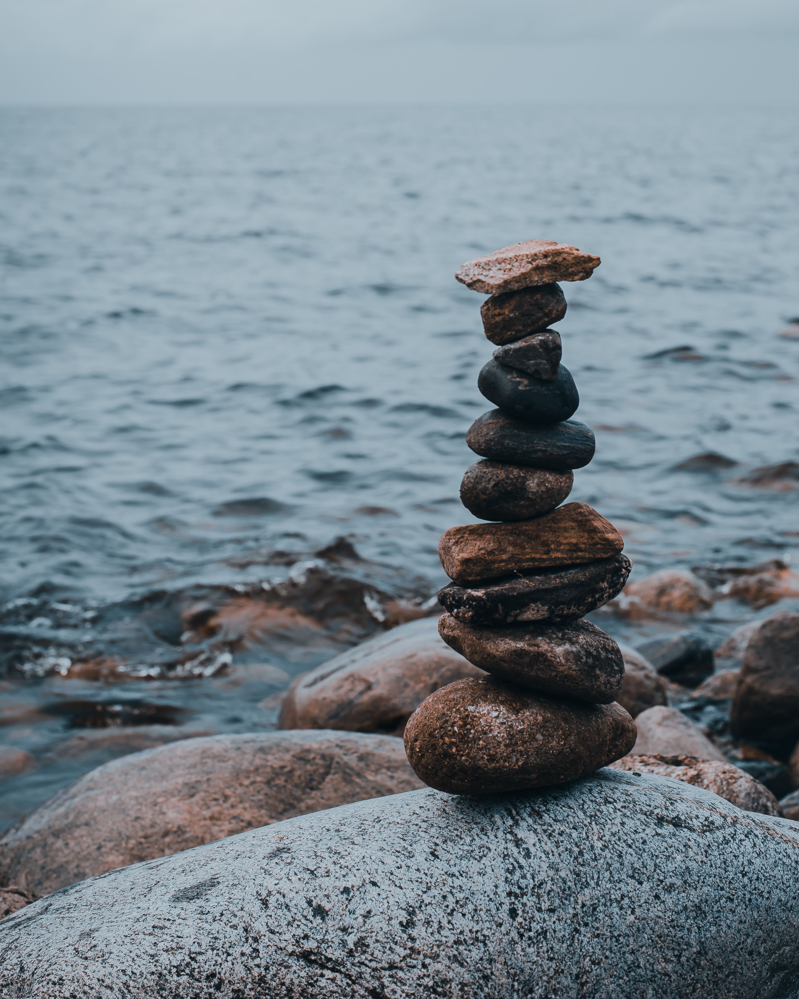 Stack of Stones on Gray Rock Near Body of Water · Free Stock Photo