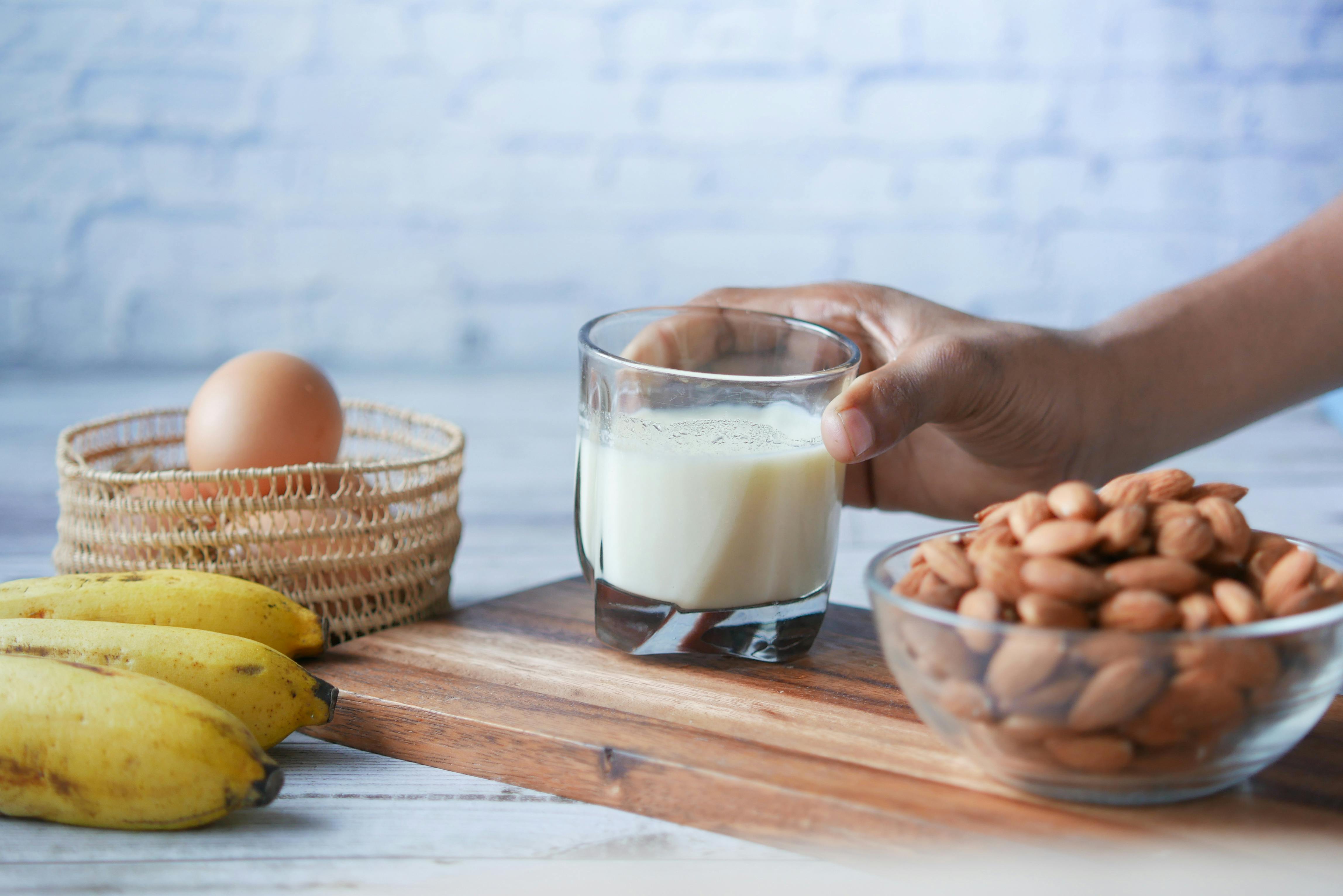 Hands Pouring Milk to Glass · Free Stock Photo