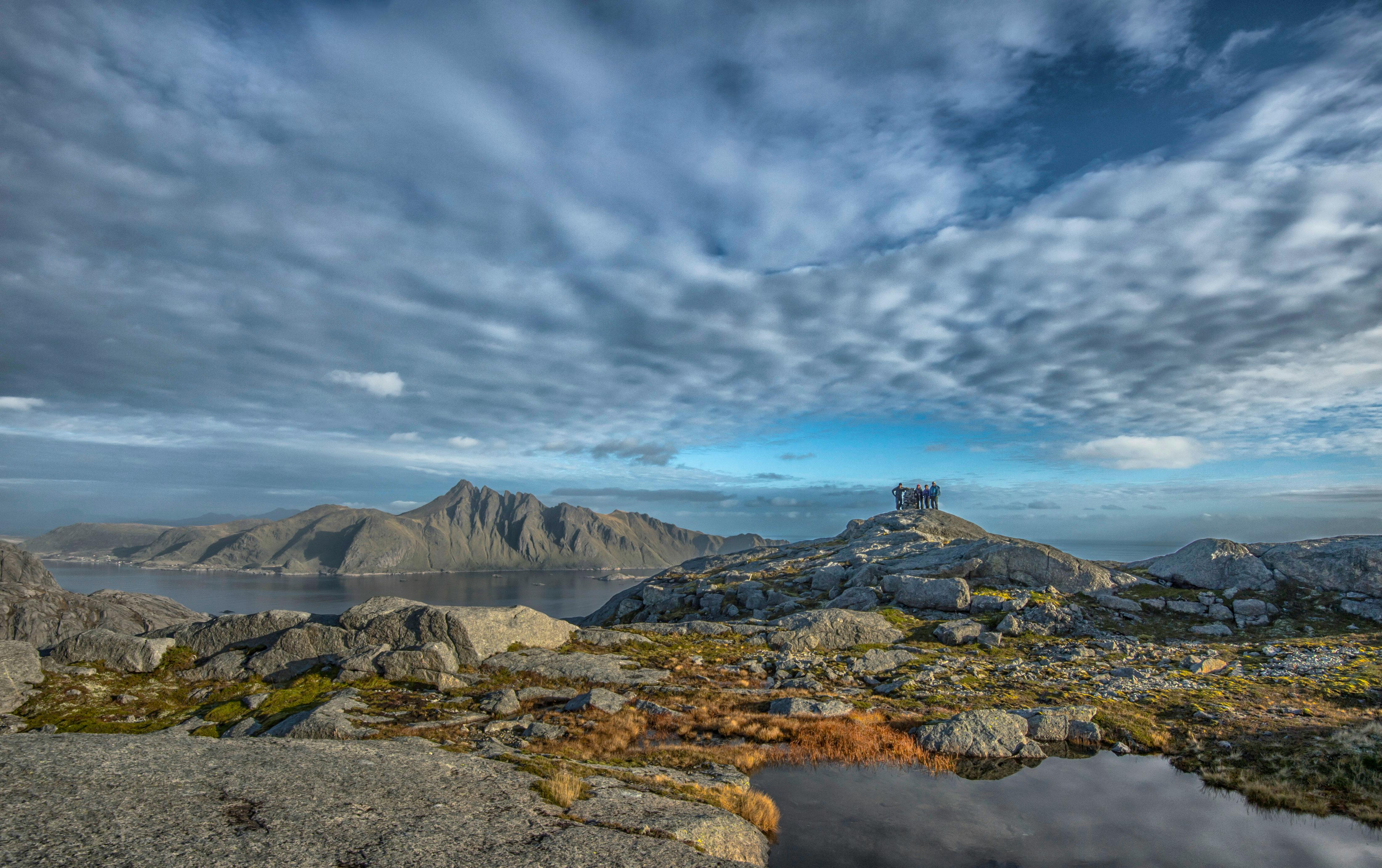 Sharp Rocky Mountain Peak and Rock in Pond · Free Stock Photo