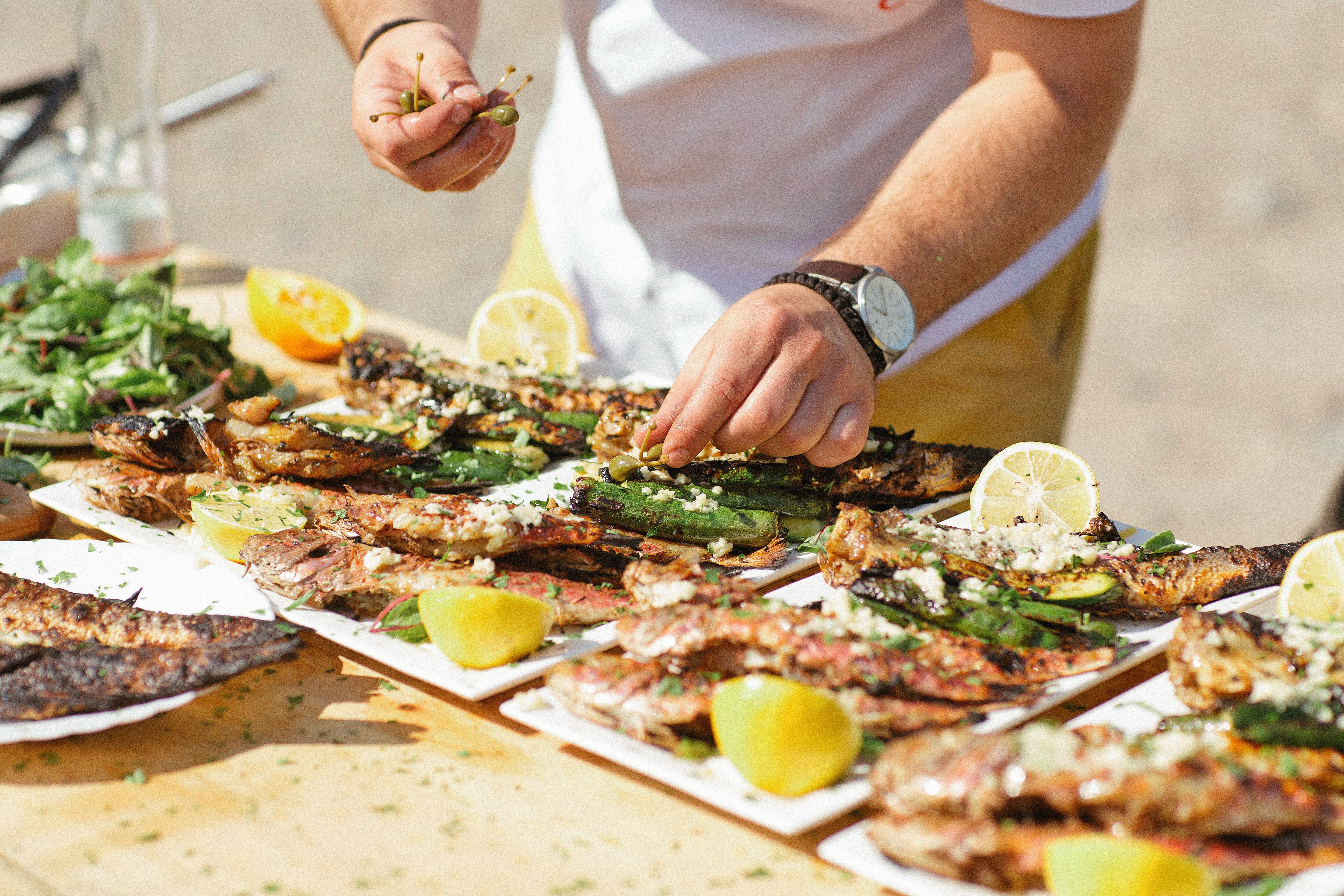 Man Seasoning Fish Dishes · Free Stock Photo