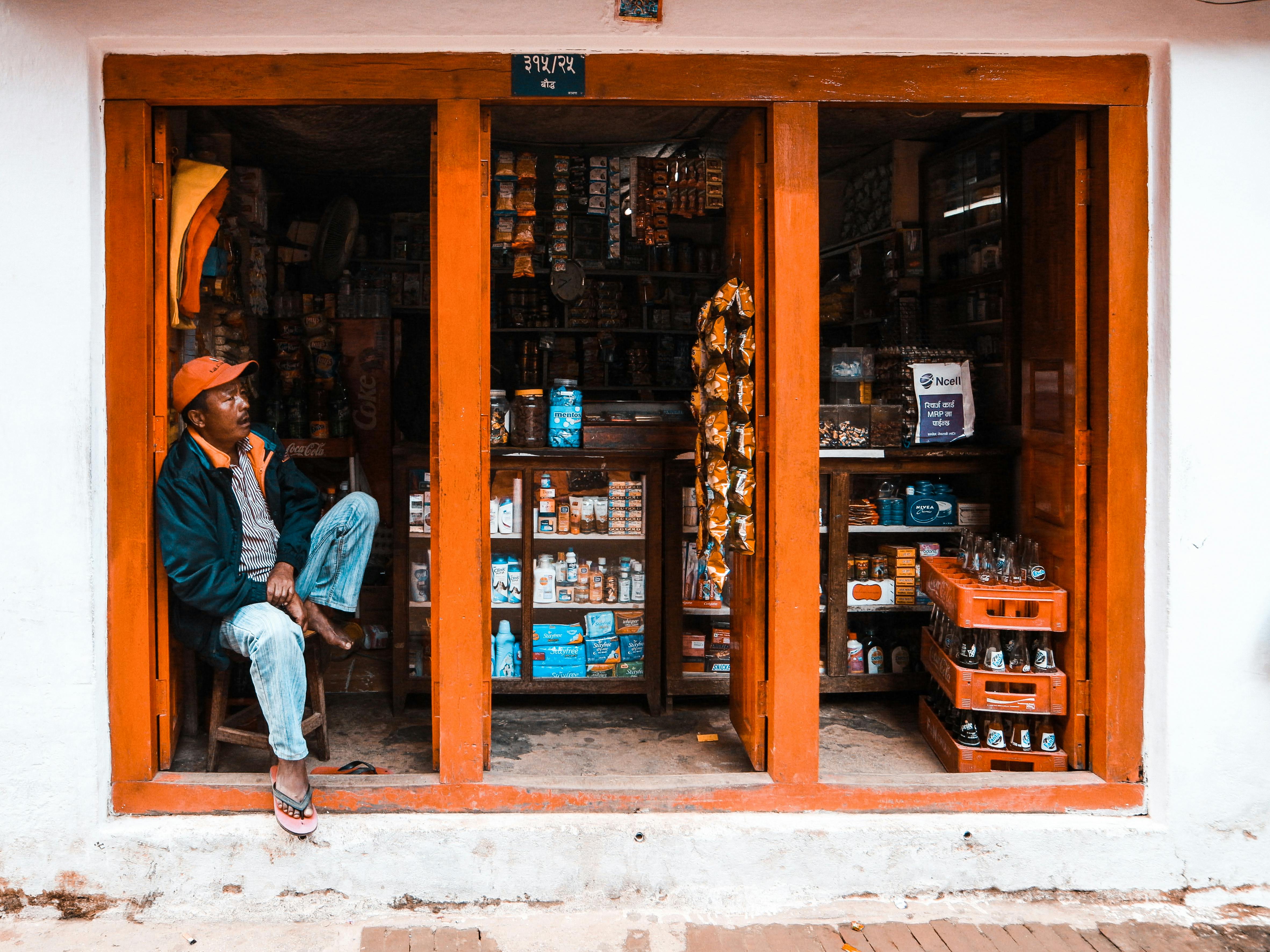 Man in the Store Sitting on the Wooden Chair · Free Stock Photo
