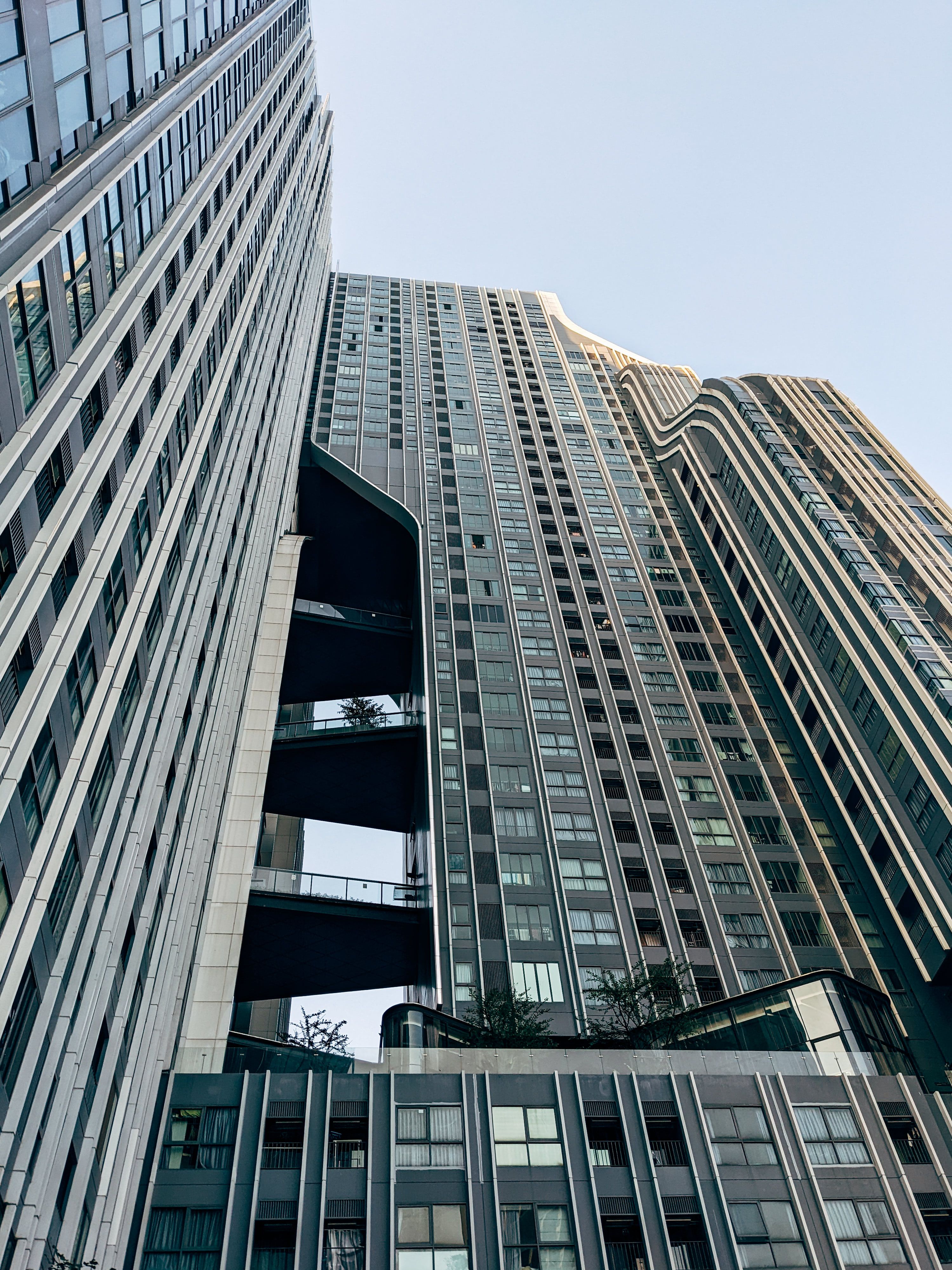 Gray scale photography of a concrete high-rise building · Free Stock Photo