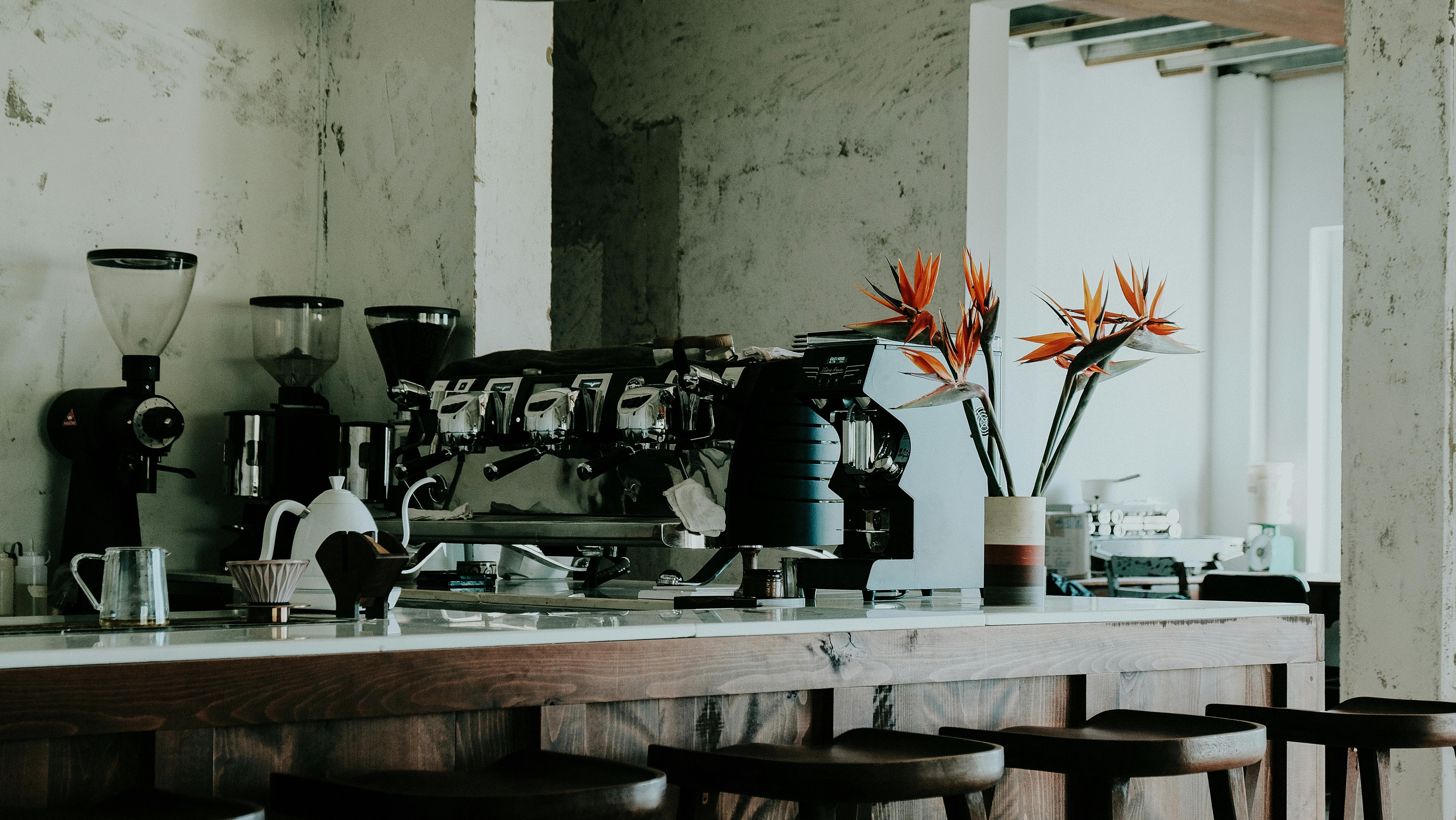 Flowers in Vase next to Coffee Machines · Free Stock Photo