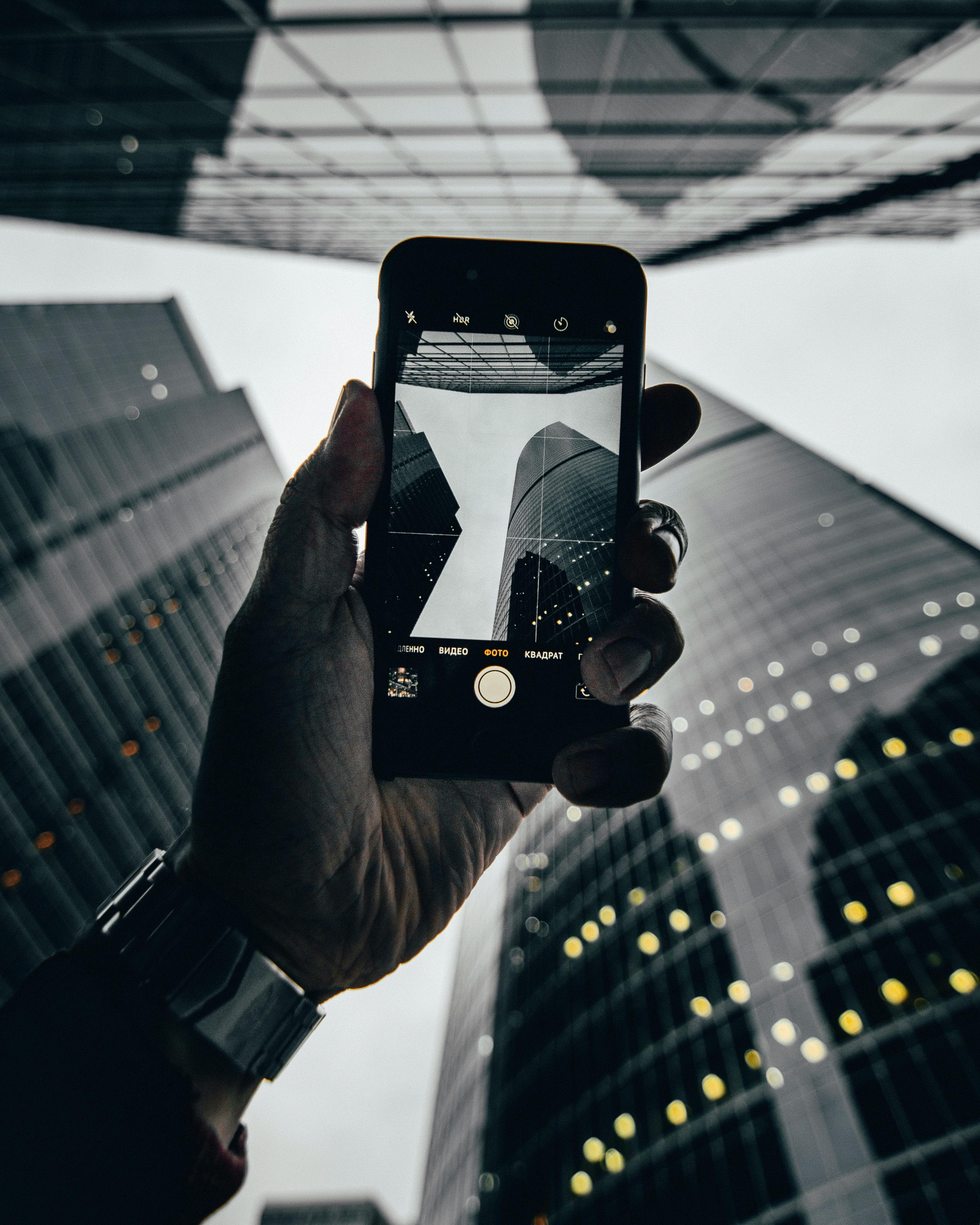 Photographing City Buildings with a Smartphone · Free Stock Photo