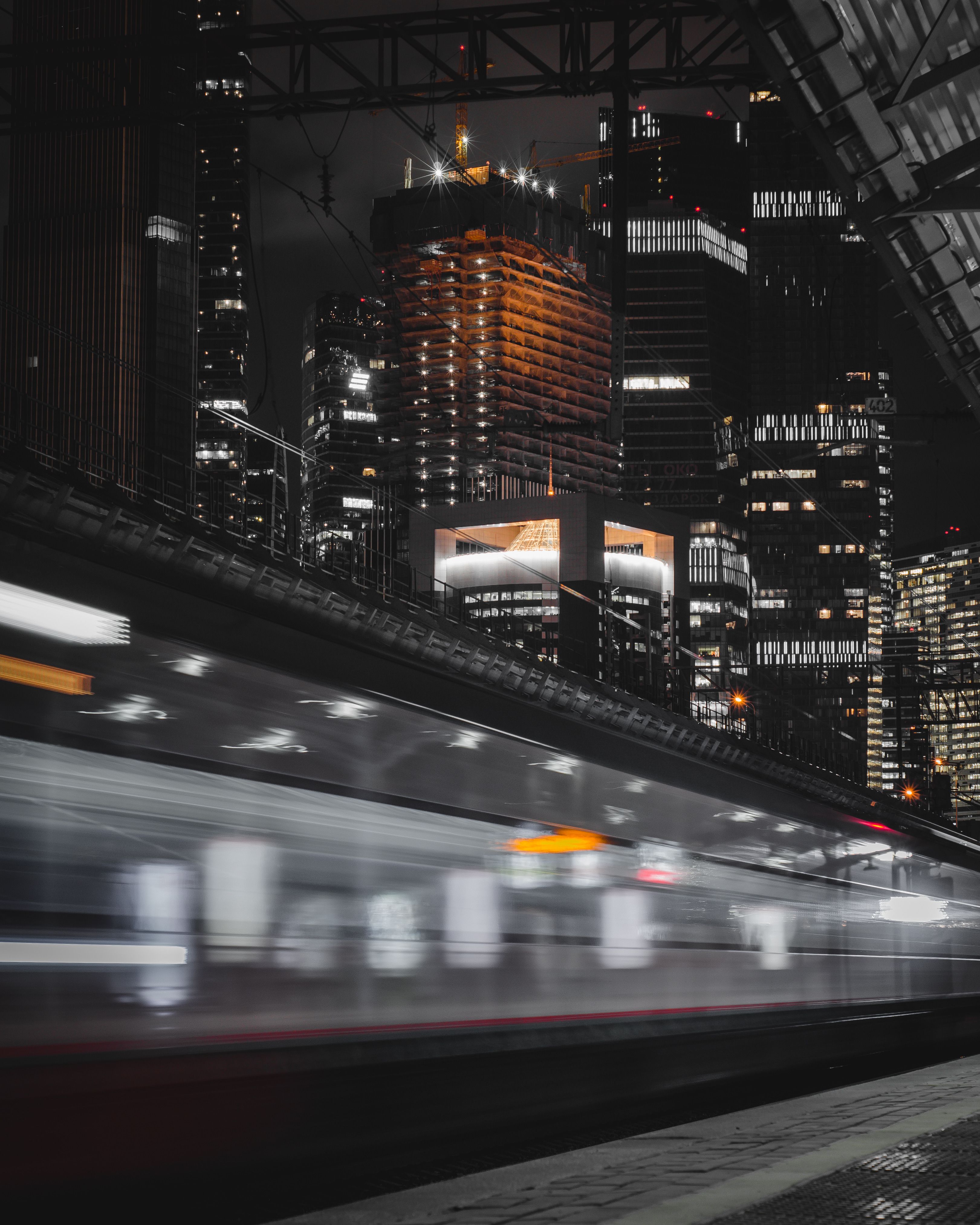 Long Exposure of a Train Passing in a Modern City Downtown at Night ...