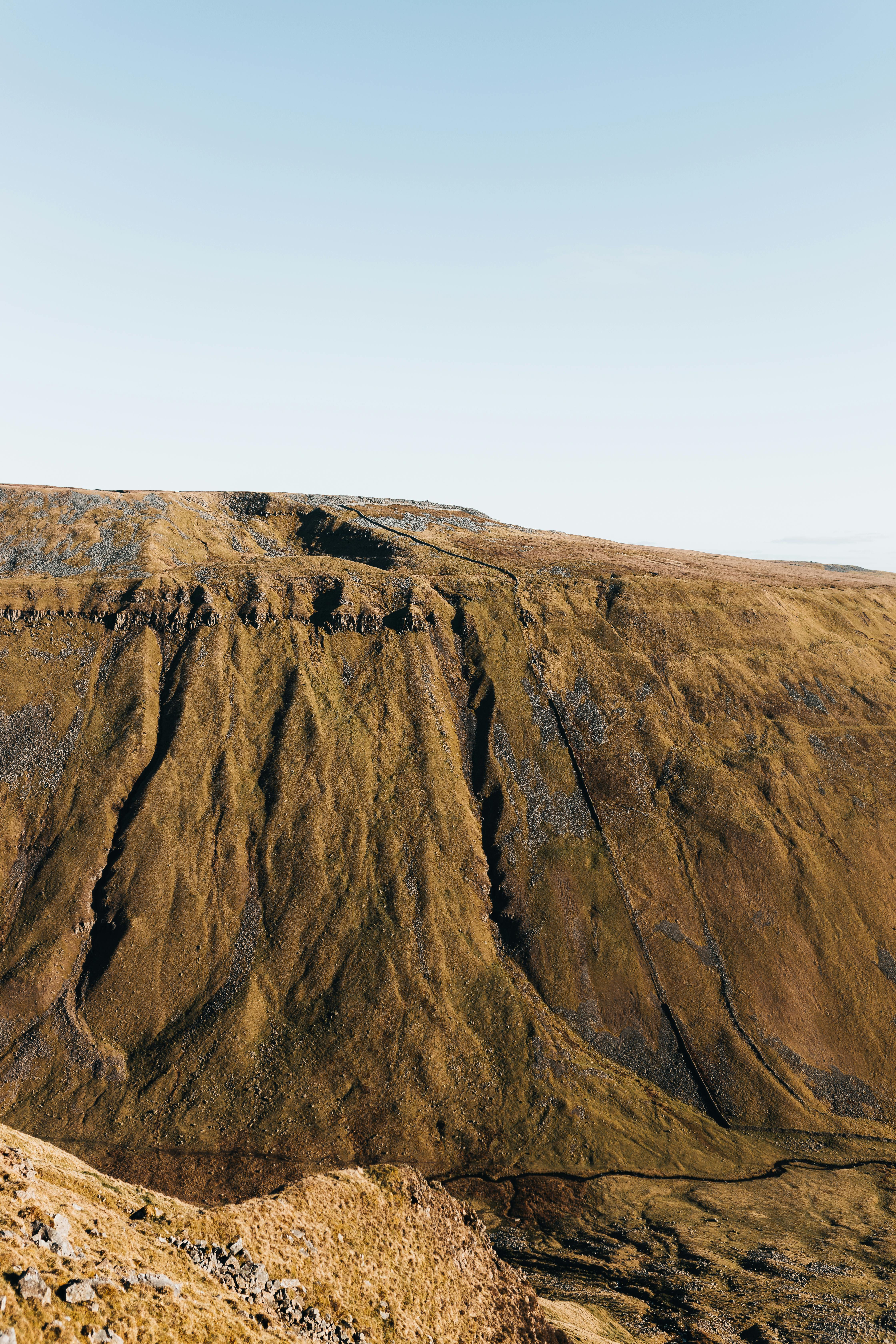 Clear Sky over Barren Hill · Free Stock Photo