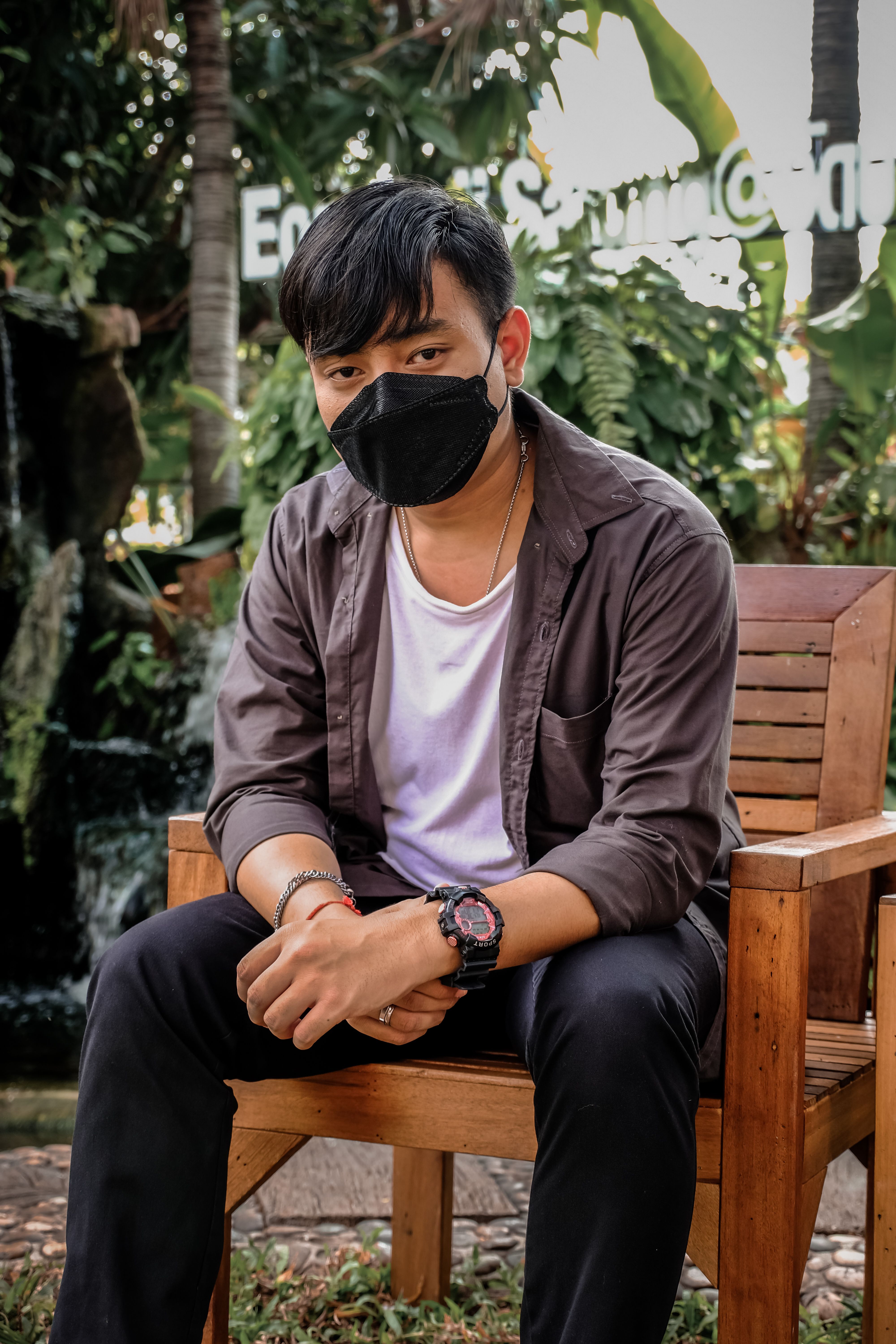 Man Biting a Flower While Sitting on a Chair · Free Stock Photo