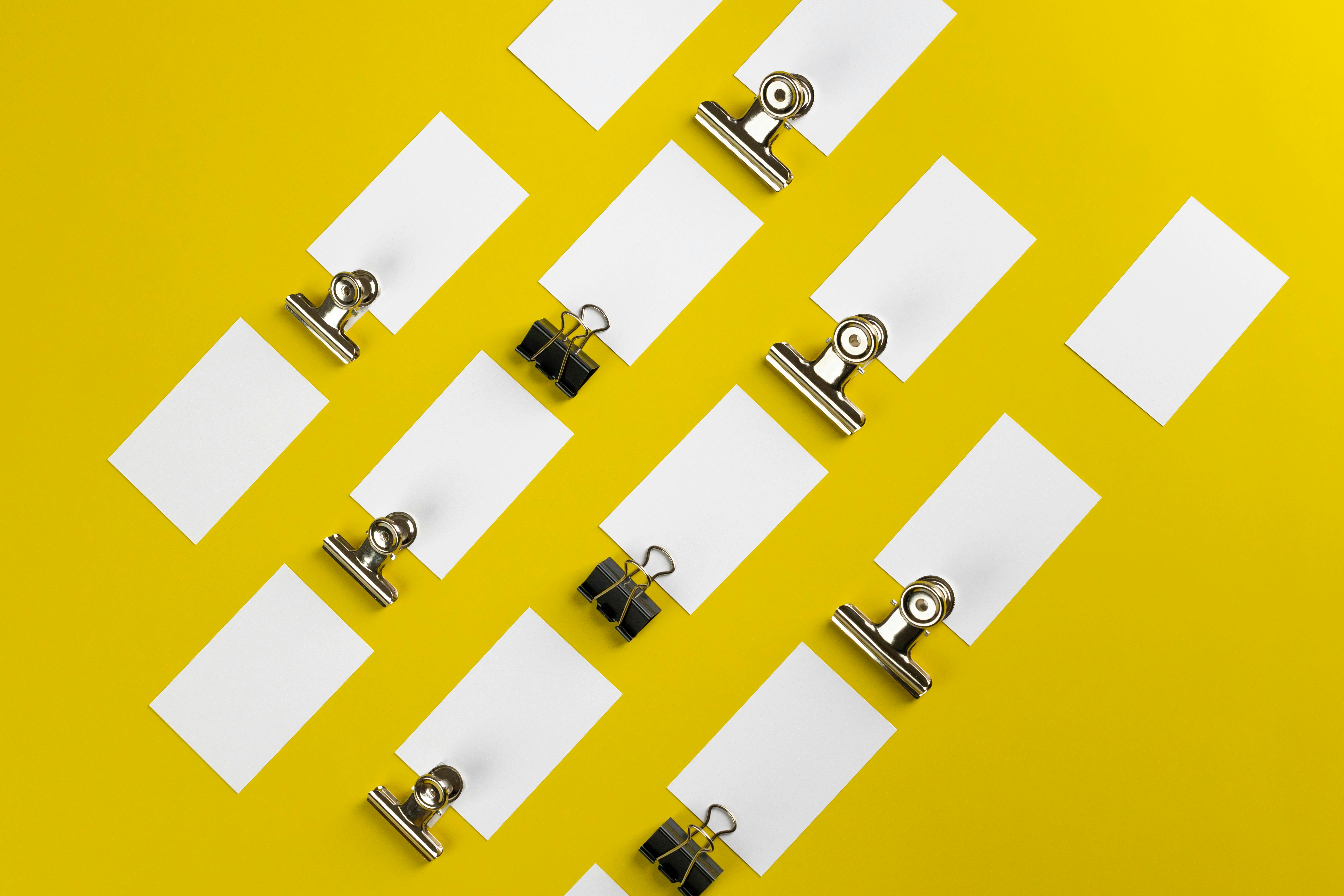 Office Clips and White Cards on Yellow Background · Free Stock Photo