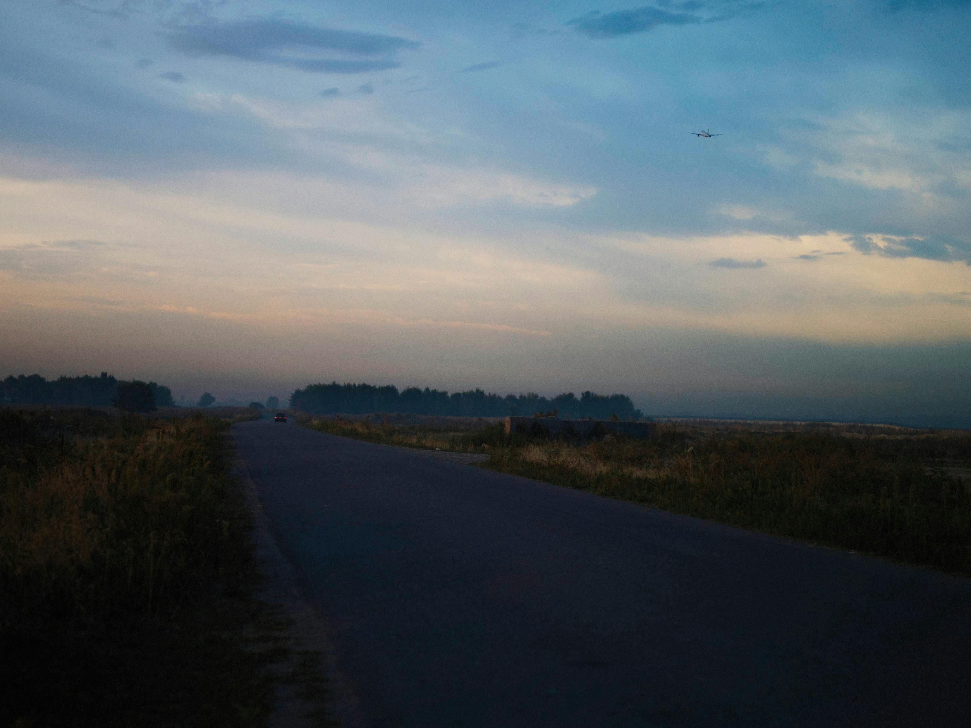 Gray Asphalt Road Between Green Grass Field · Free Stock Photo