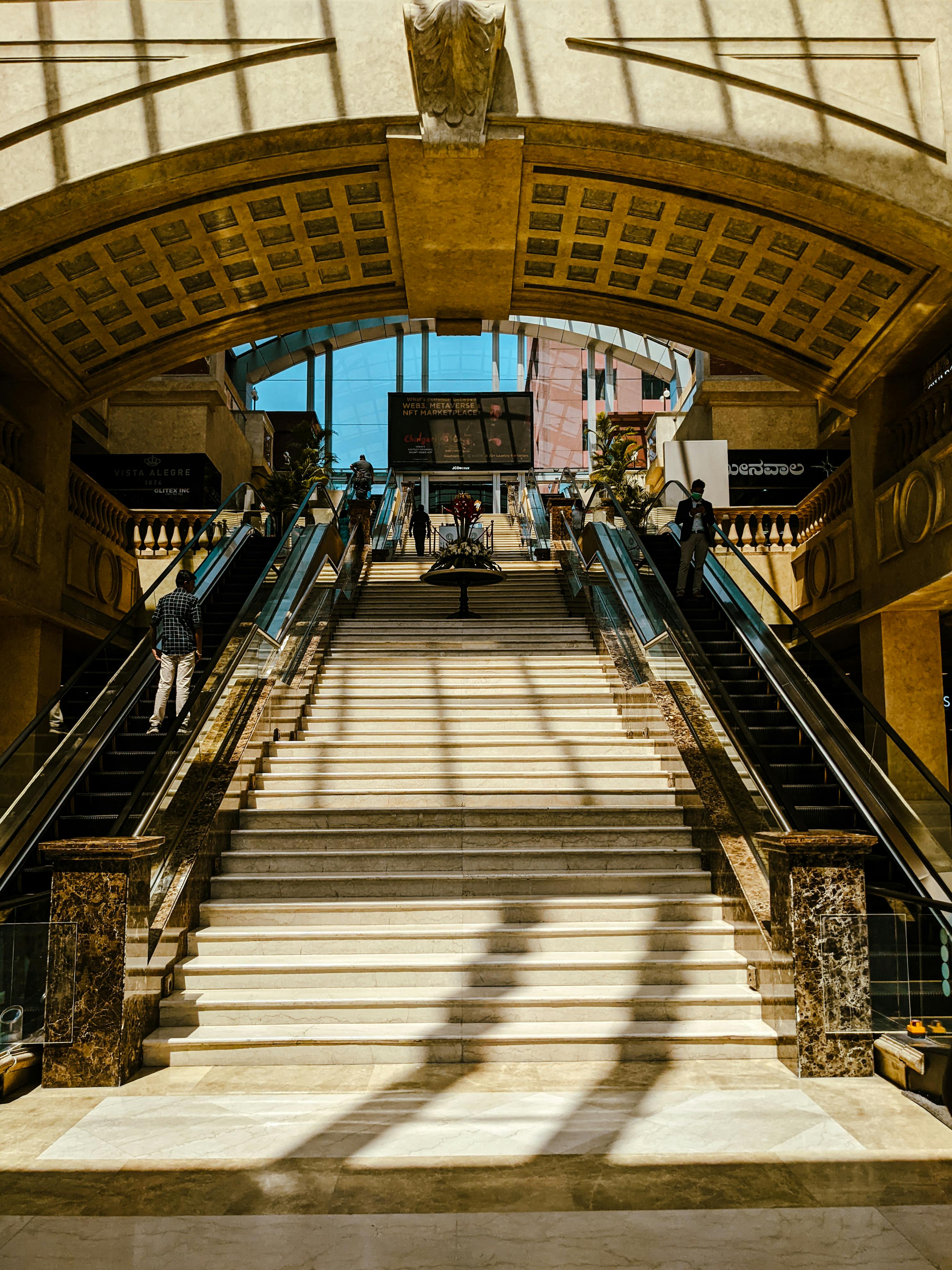 Person Sitting in Shadow in Building Entrance · Free Stock Photo