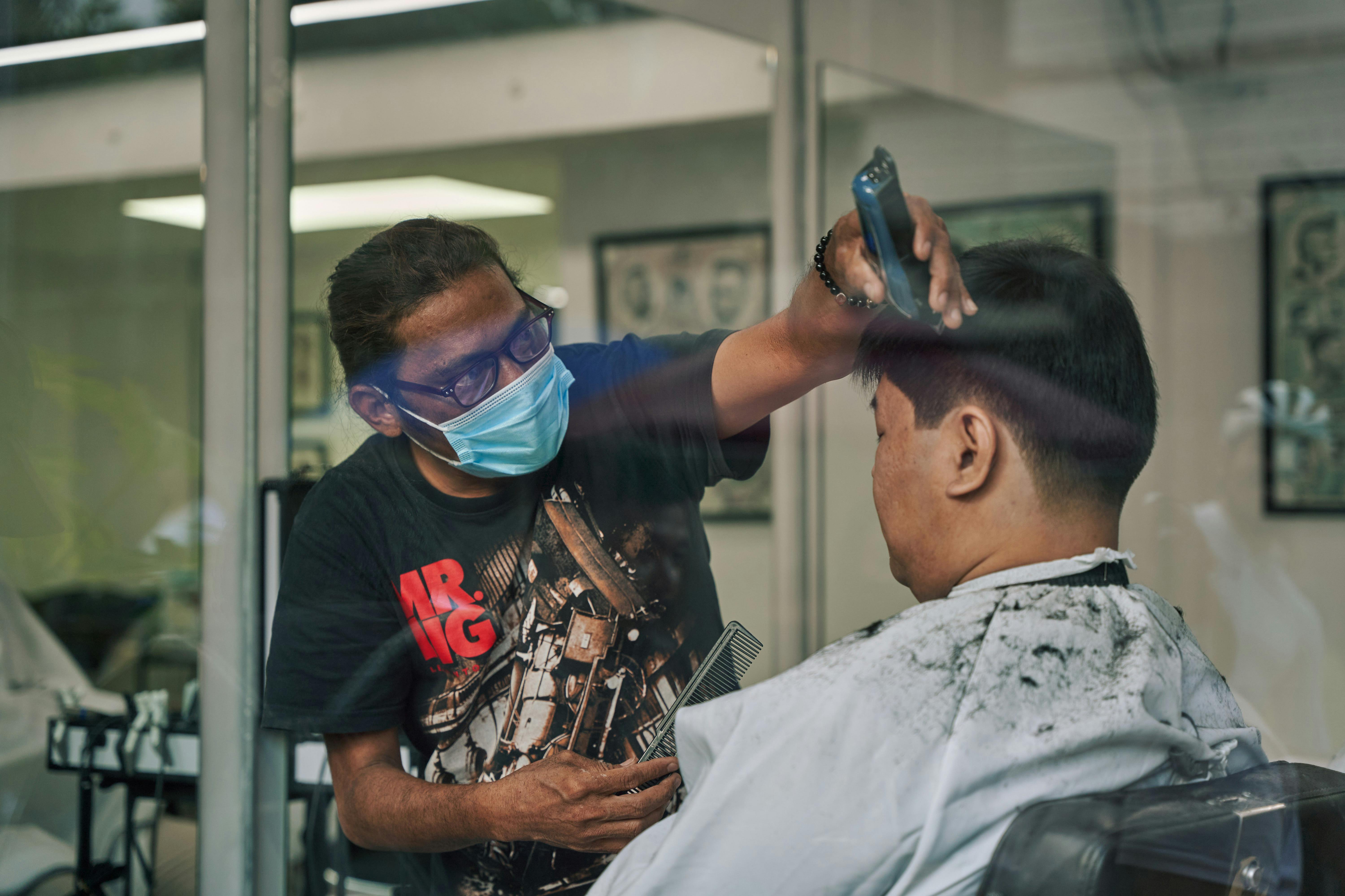 Man Cutting Another Man's Hair · Free Stock Photo