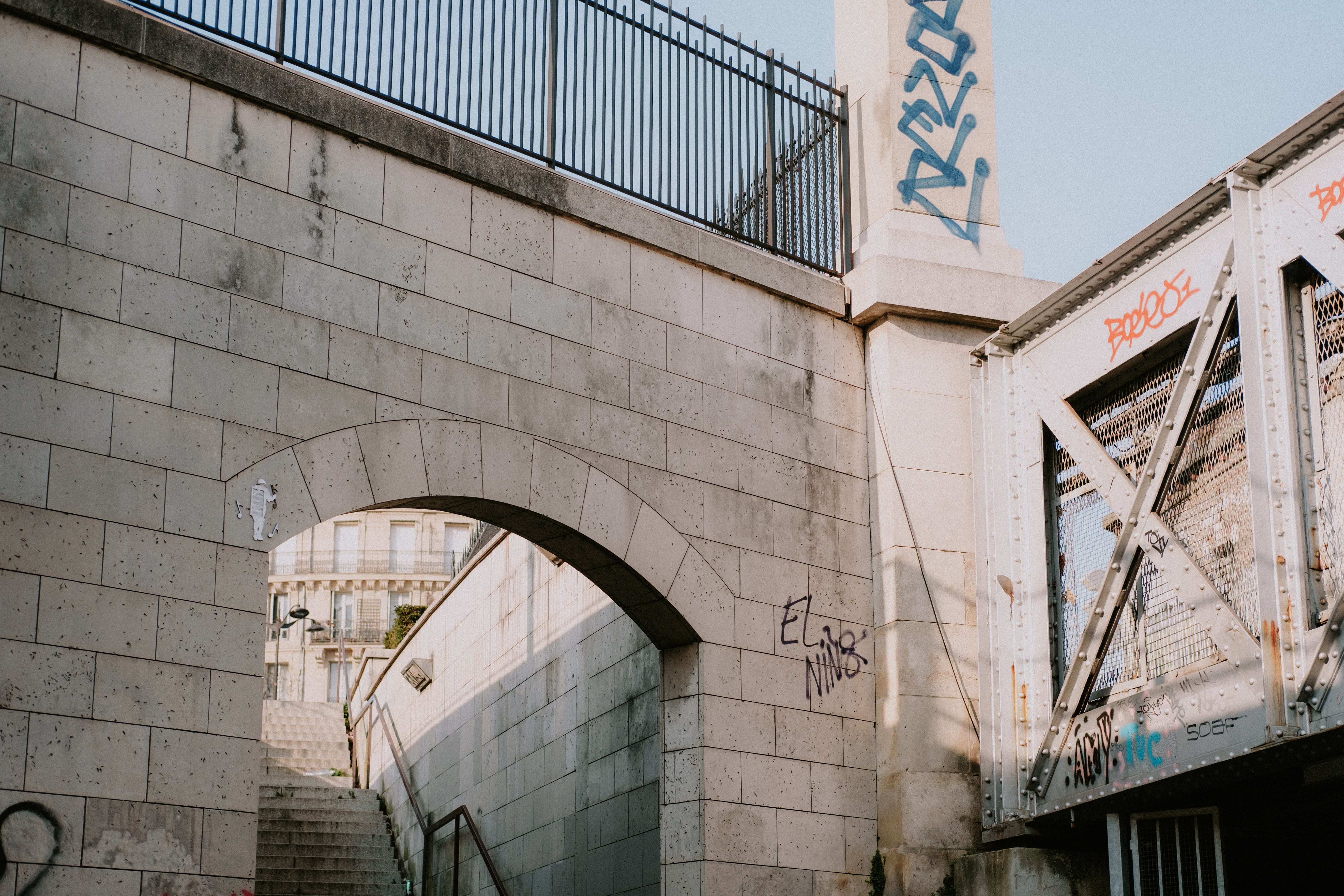 Tags on Wall near Iron and Steel Construction · Free Stock Photo