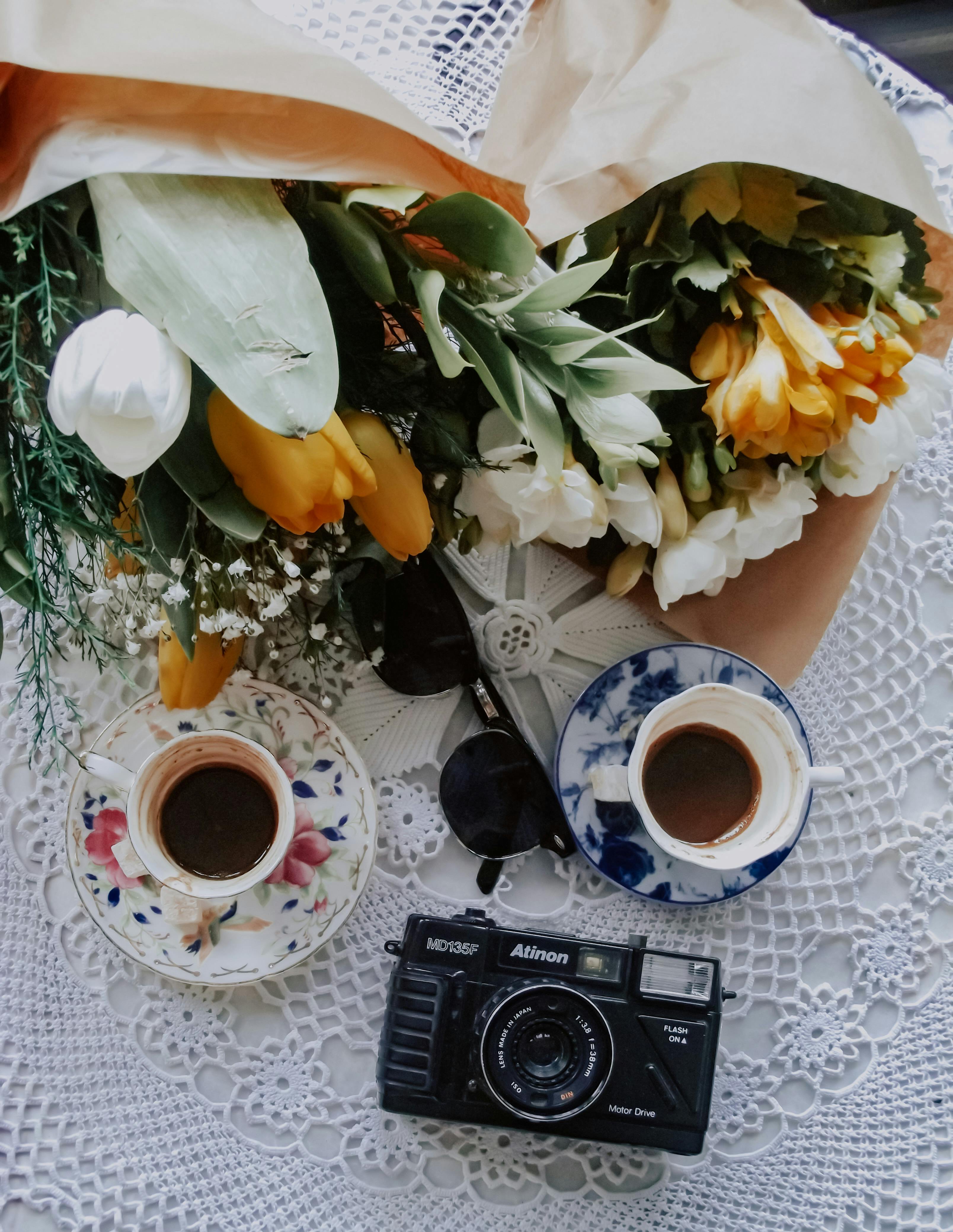 A Cup of Coffee and Camera on the Table · Free Stock Photo
