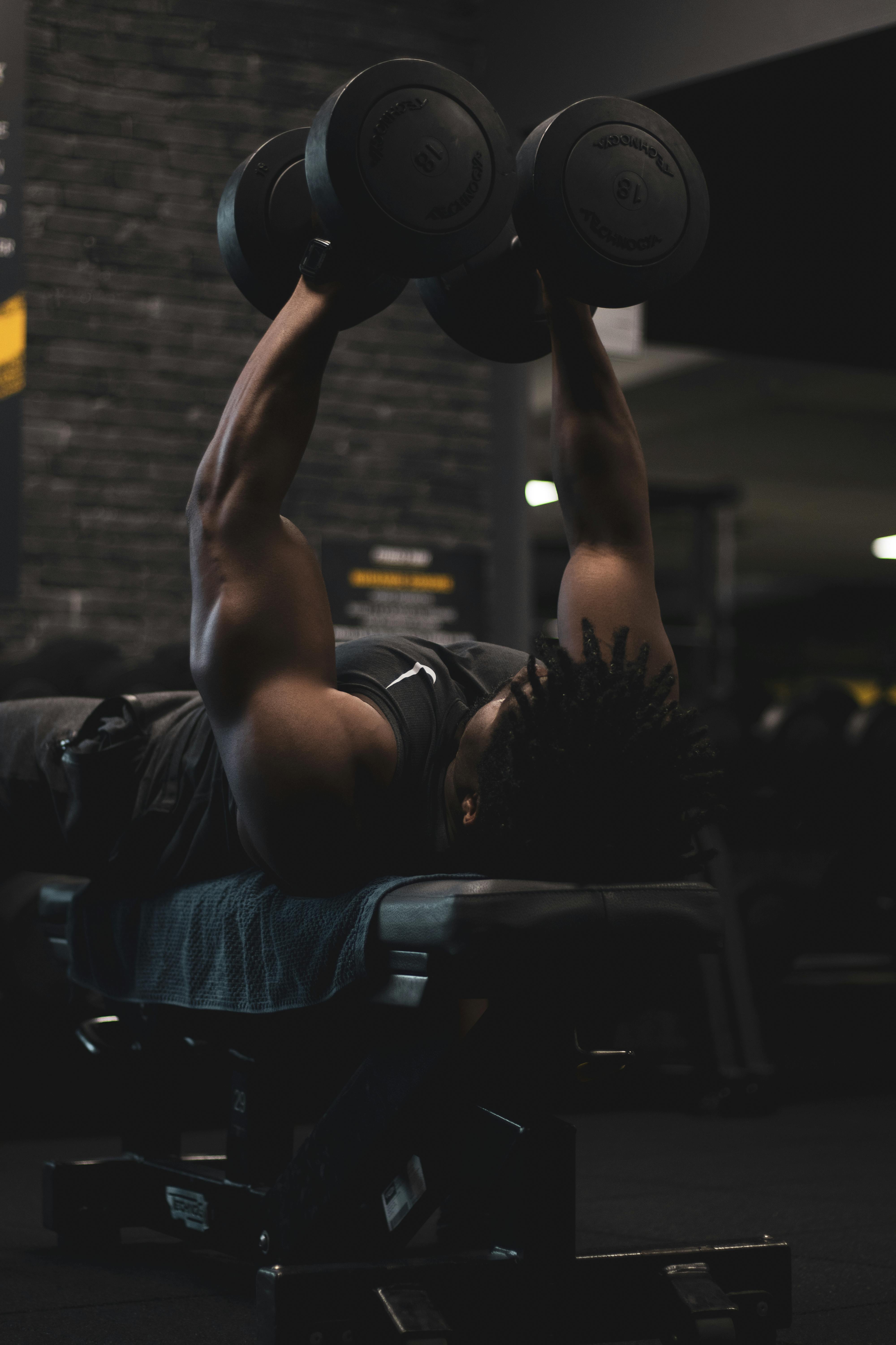 A Man Doing a Dumbbell Chest Press · Free Stock Photo